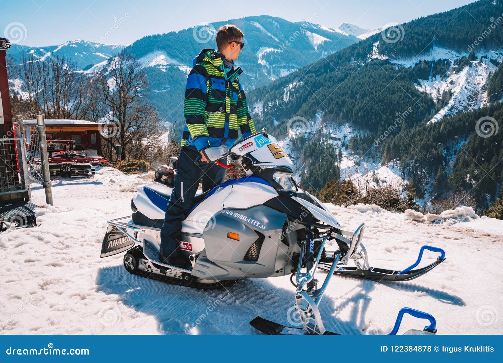 Young Man Riding a Snowmobile on a Track in the Middle of the Austrian ... Young Man Riding a Snowmobile on a Track in the Middle of the Austrian ...