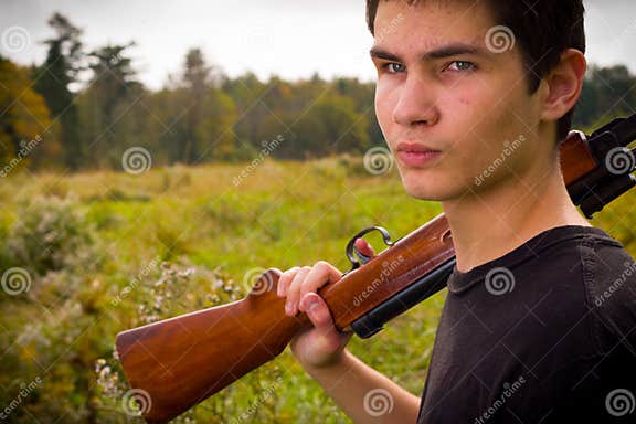 Young man with rifle stock photo. Image of outdoor, season - 21307936