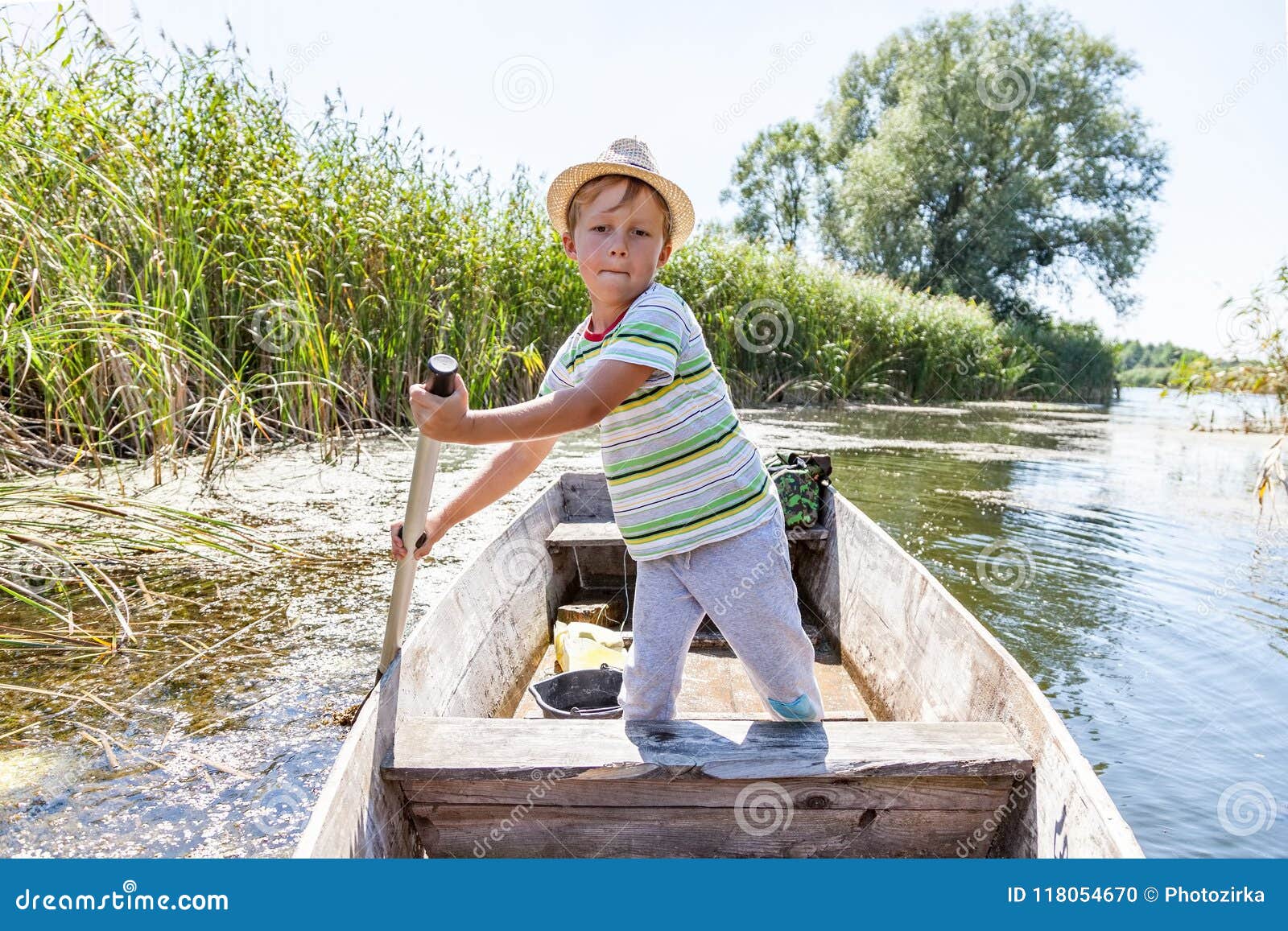 Young man rowing a boat stock photo. Image of hard, active - 118054670