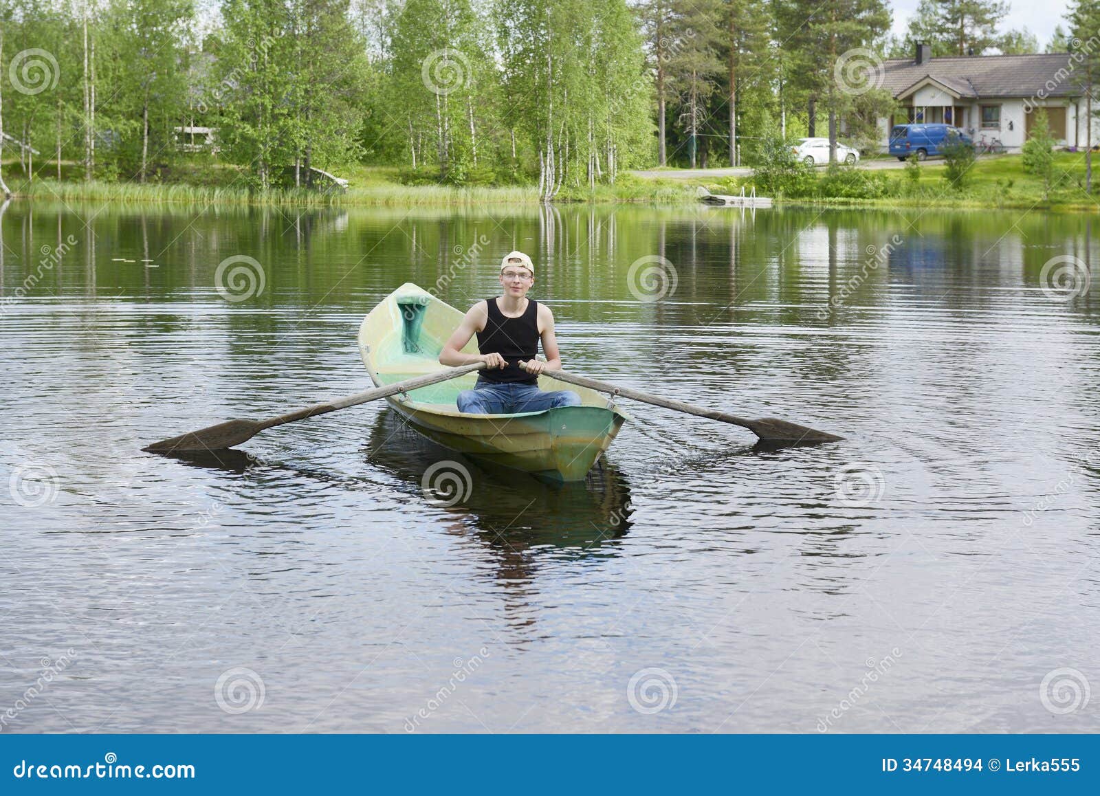 Young Man Rowing a Boat on a Lake Stock Photo - Image of casual ...