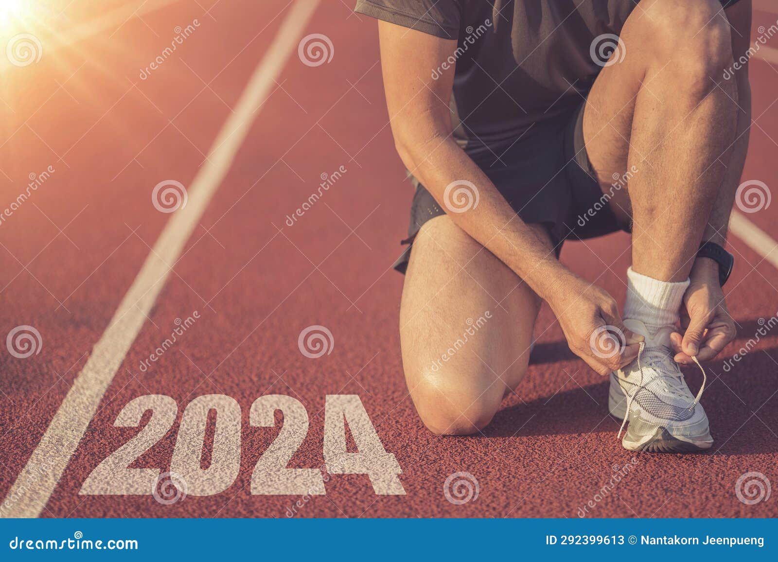 Young Man Runner Tying Shoelace on Running Track with Numbers 2024 ...