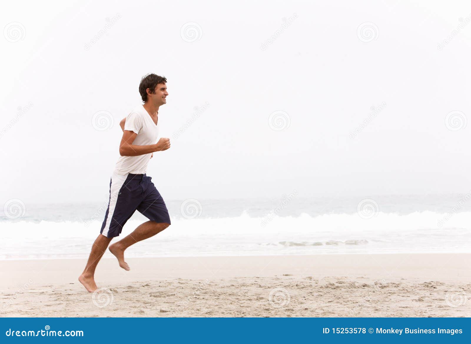 Young Man Running Along Winter Beach Stock Photo - Image of male ...