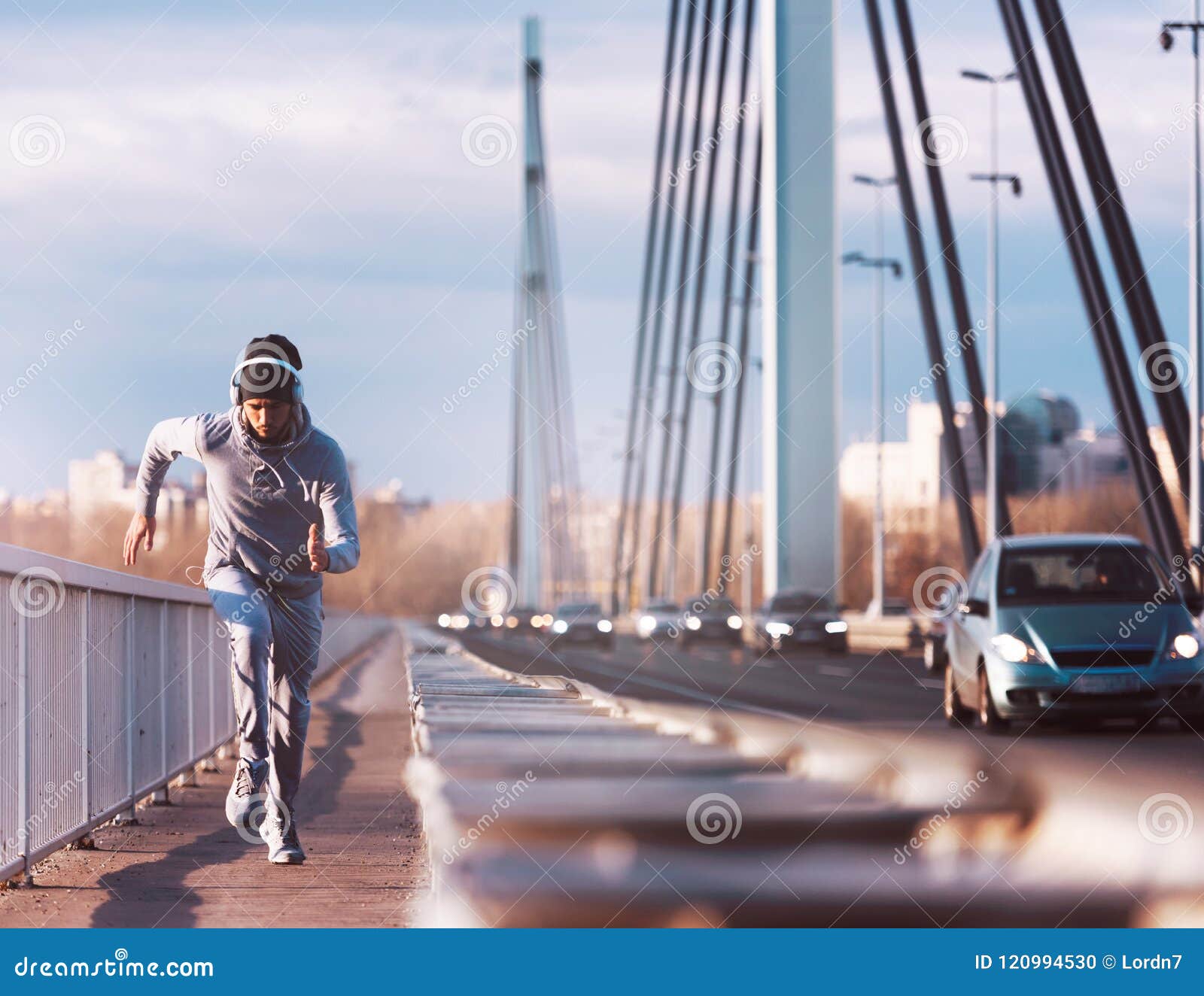 A Young Man Running on the Bridge Along a River. Stock Photo - Image of ...