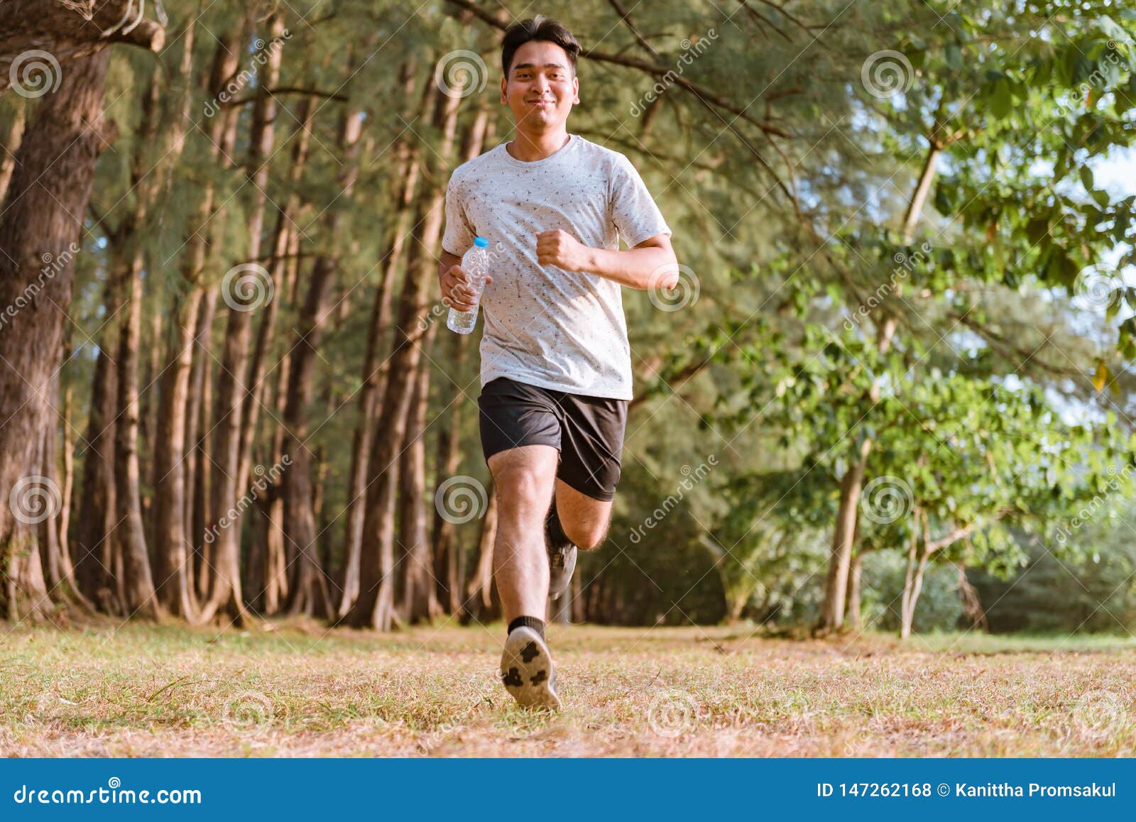 Young Man Running and Doing Workout Outdoors at the Park. Stock Photo ...