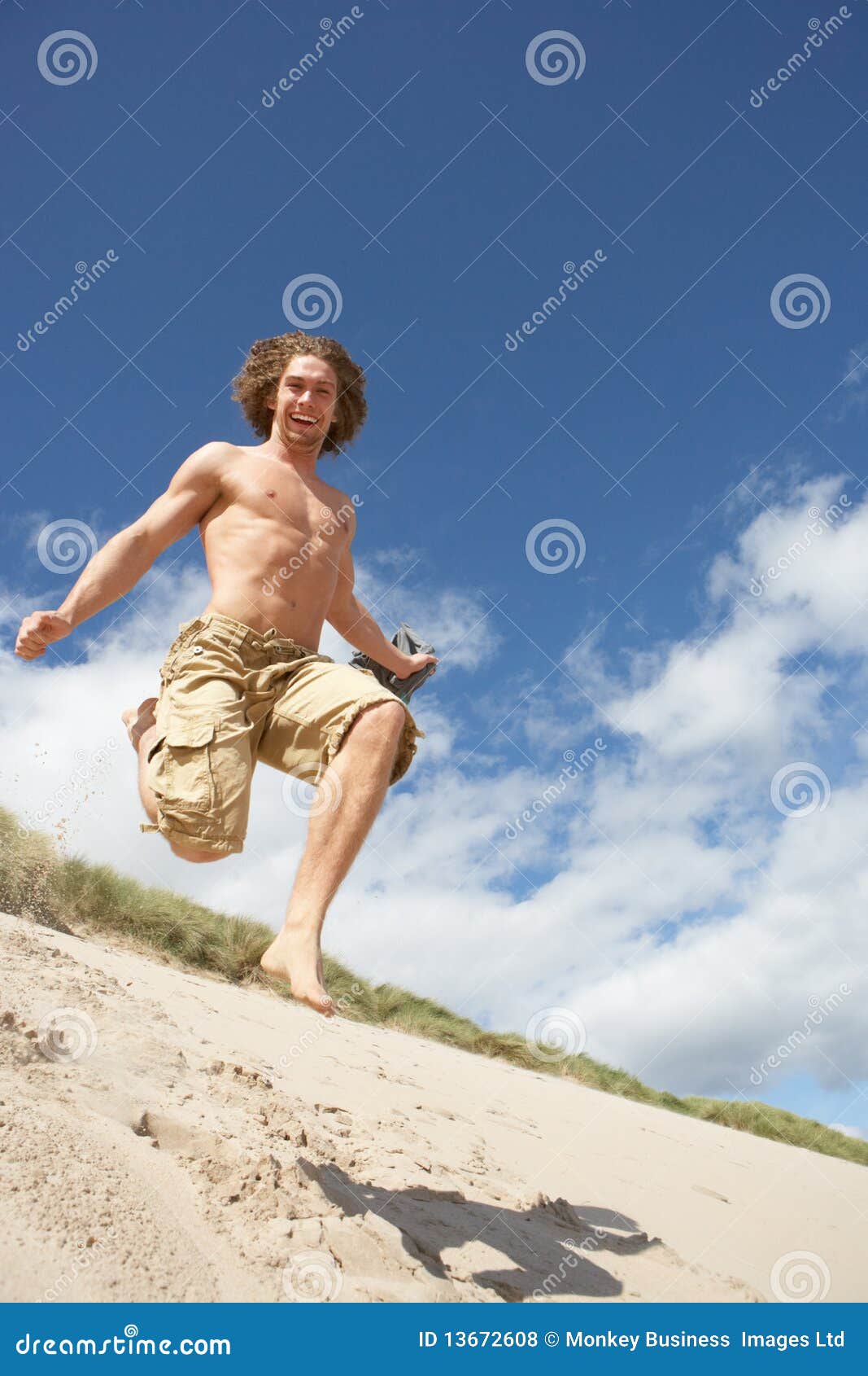 Young Man Running Down Sand Dune Stock Photo - Image of enjoying ...