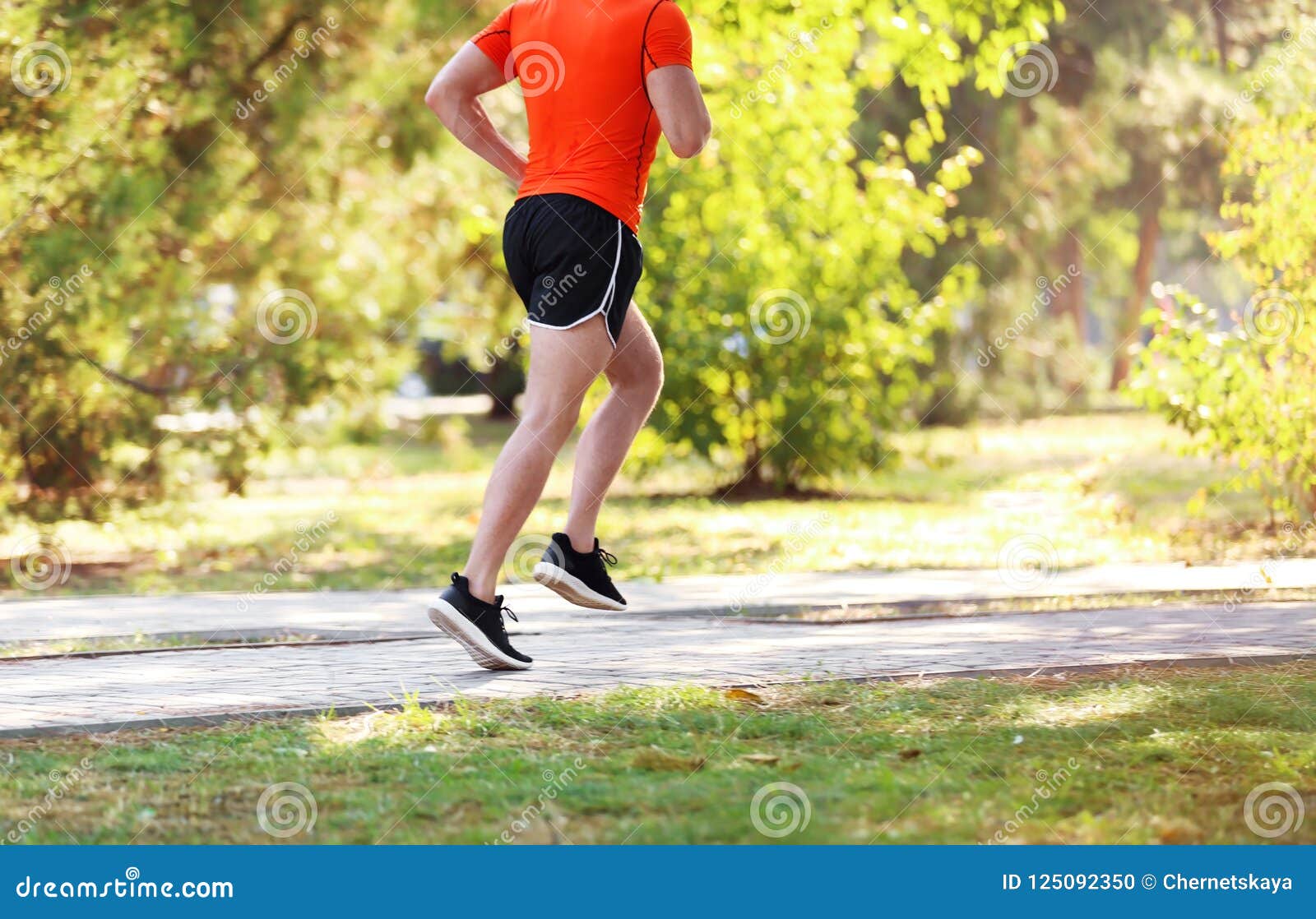 Young man running in park stock photo. Image of green - 125092350