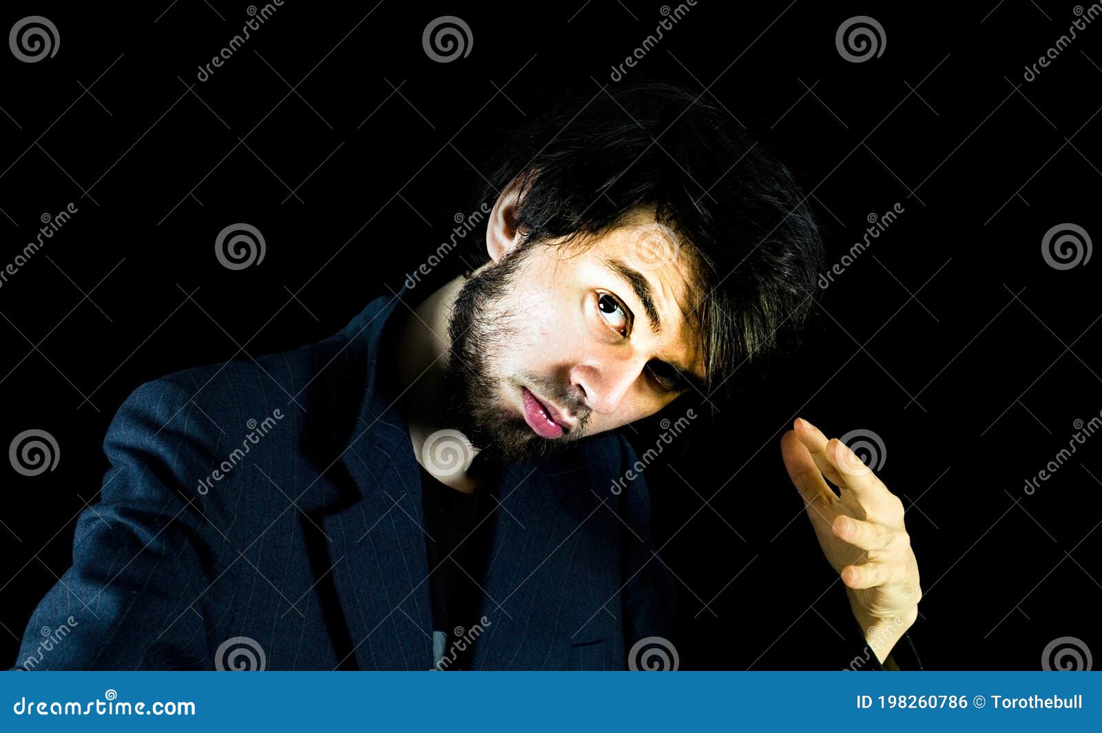 Young Man`s Face Being Hit with Light while he Poses, Looking at the ...