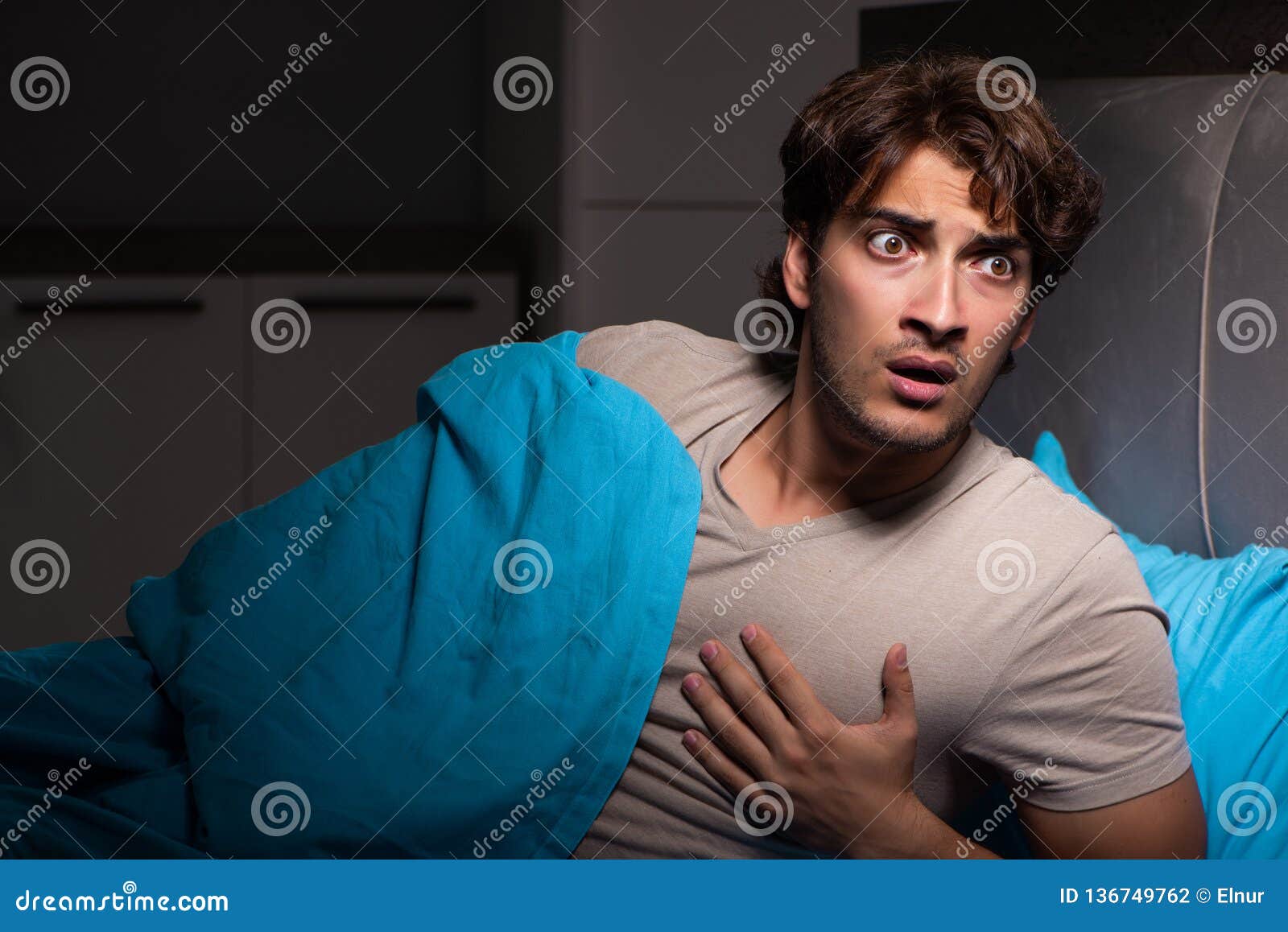The Young Man Scared in His Bed Having Nightmares Stock Photo - Image ...