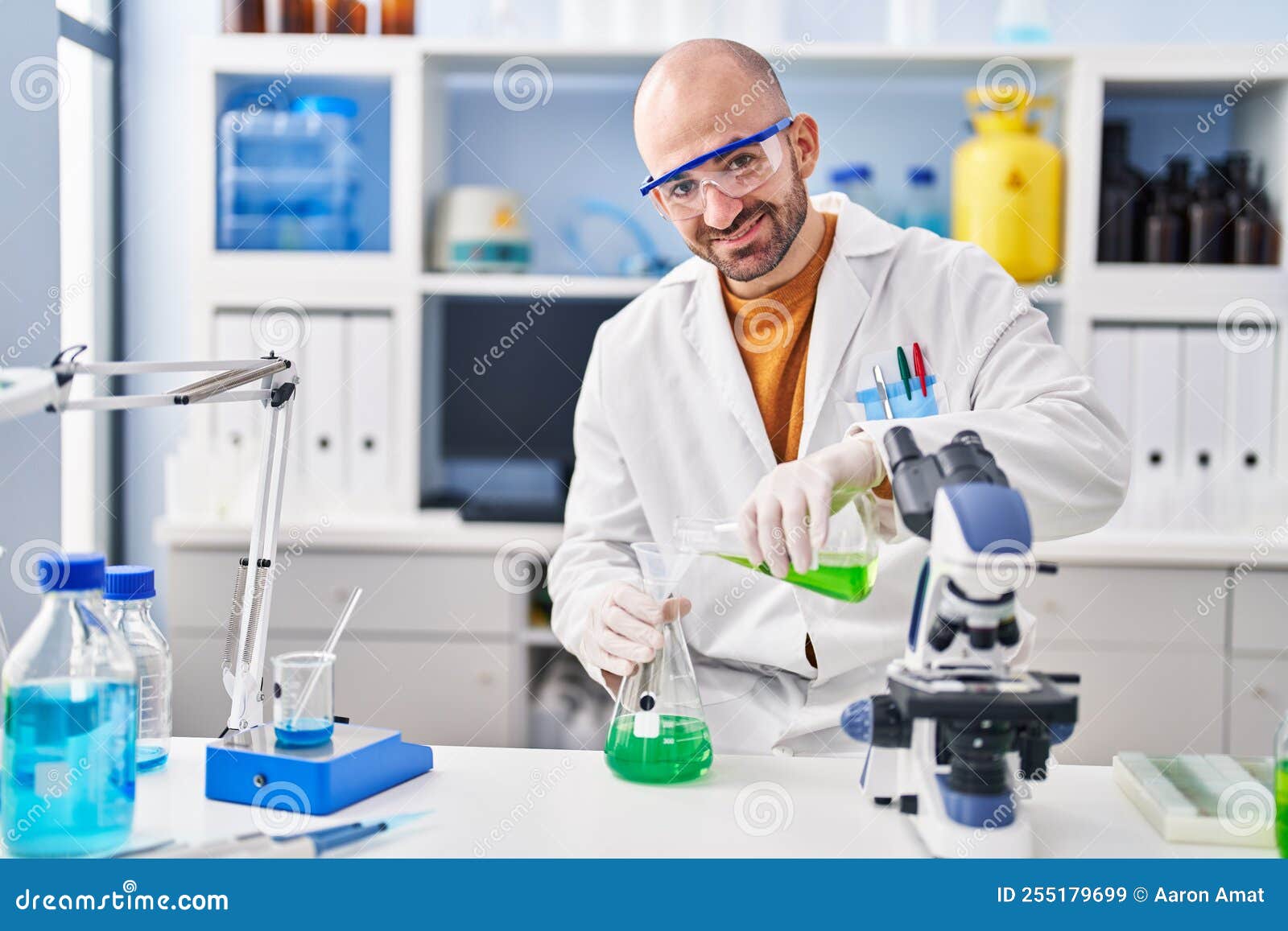 Young Man Scientist Measuring Liquid at Laboratory Stock Image - Image ...