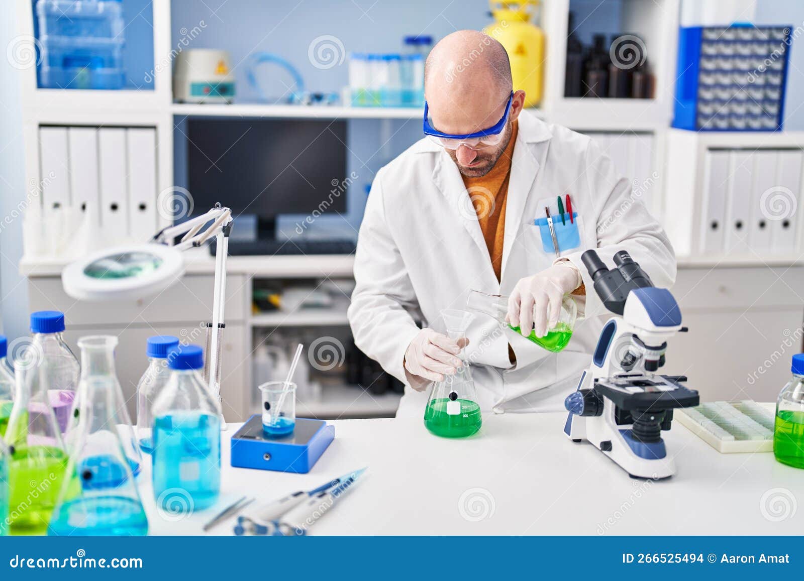 Young Man Scientist Measuring Liquid at Laboratory Stock Photo - Image ...