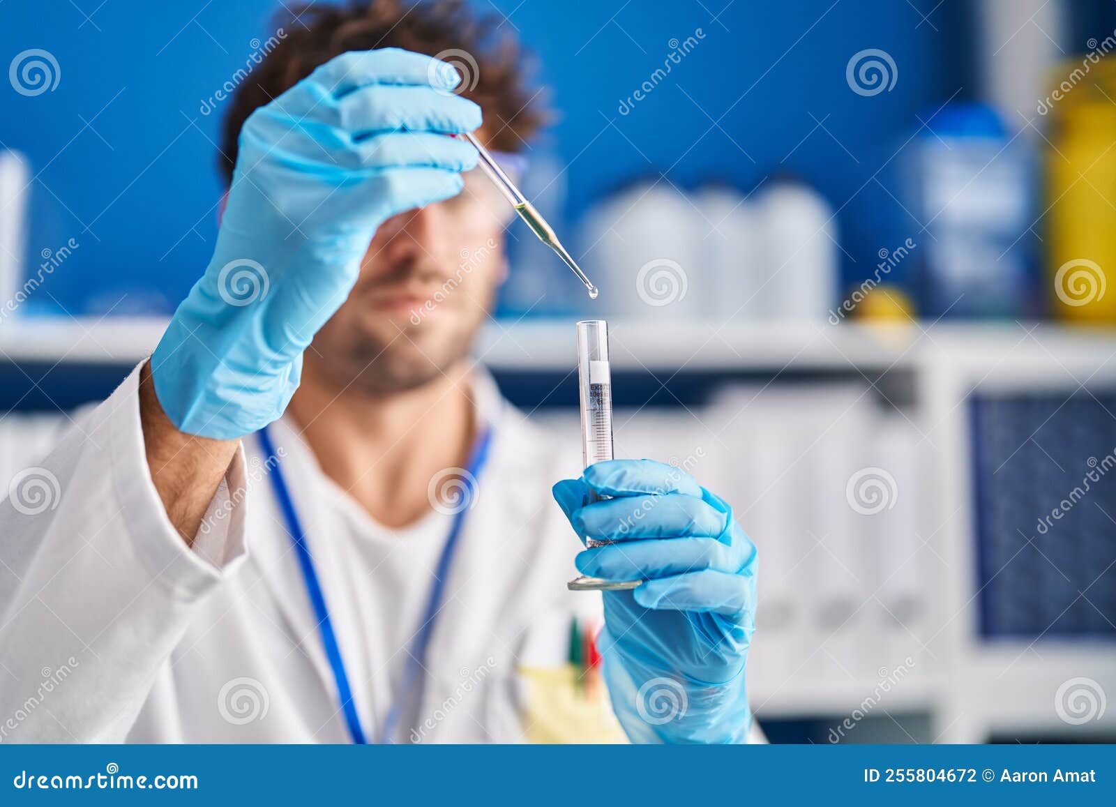 Young Man Scientist Pouring Liquid on Test Tube at Laboratory Stock ...