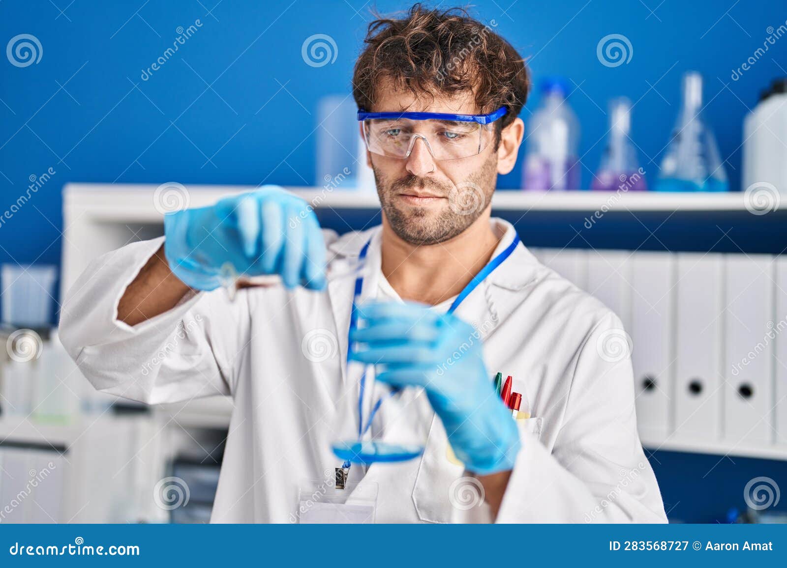 Young Man Scientist Pouring Liquid on Test Tube at Laboratory Stock ...