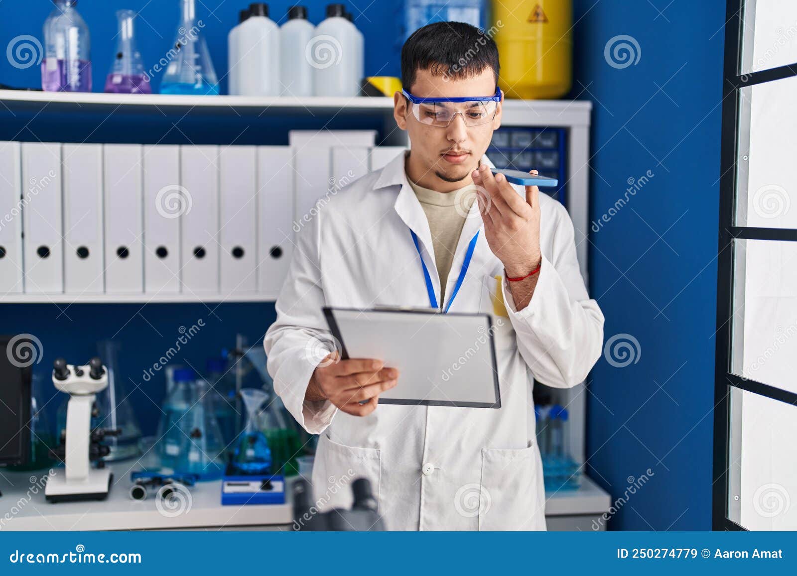 Young Man Scientist Talking on the Smartphone Reading Document at ...