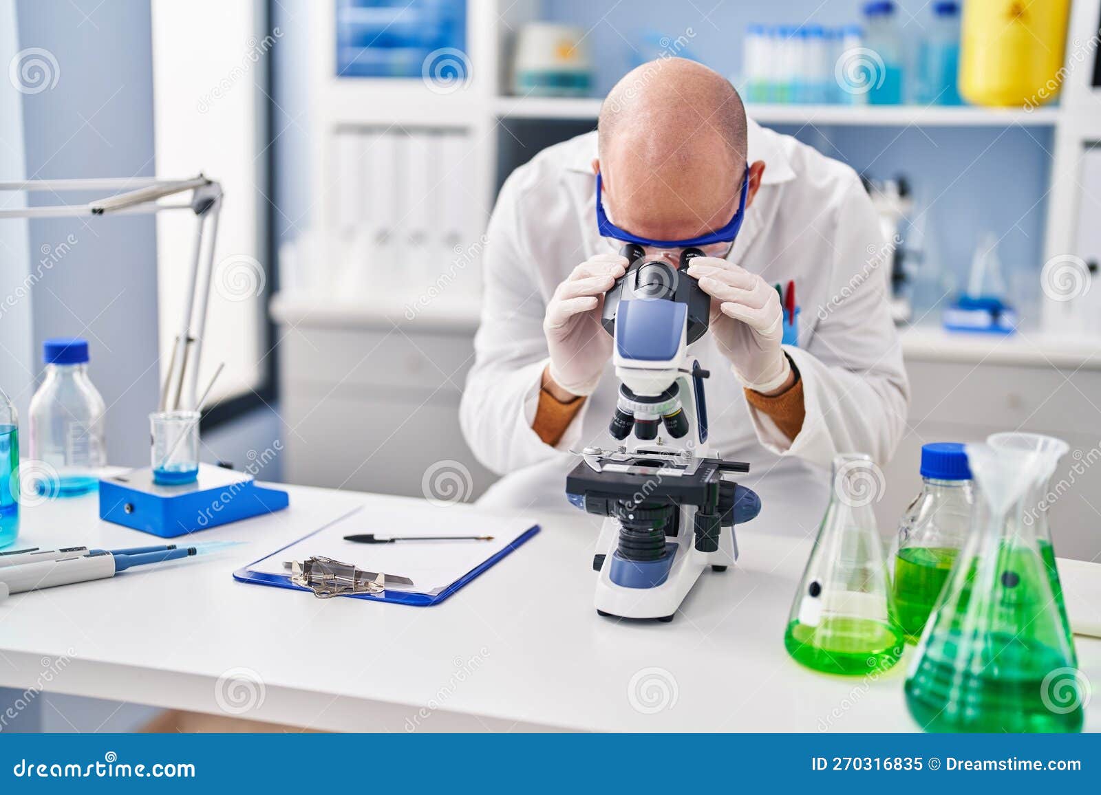 Young Man Scientist Using Microscope at Laboratory Stock Image - Image ...