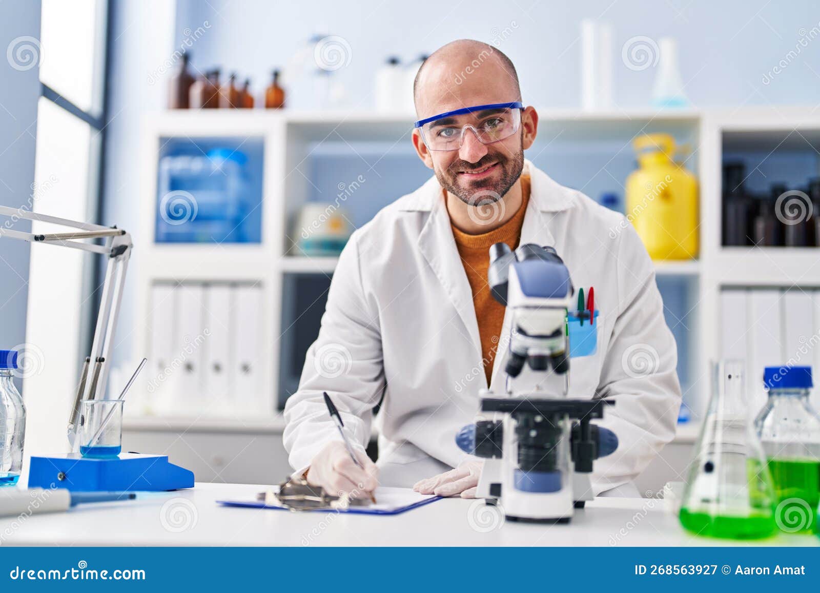 Young Man Scientist Writing on Clipboard at Laboratory Stock Image ...
