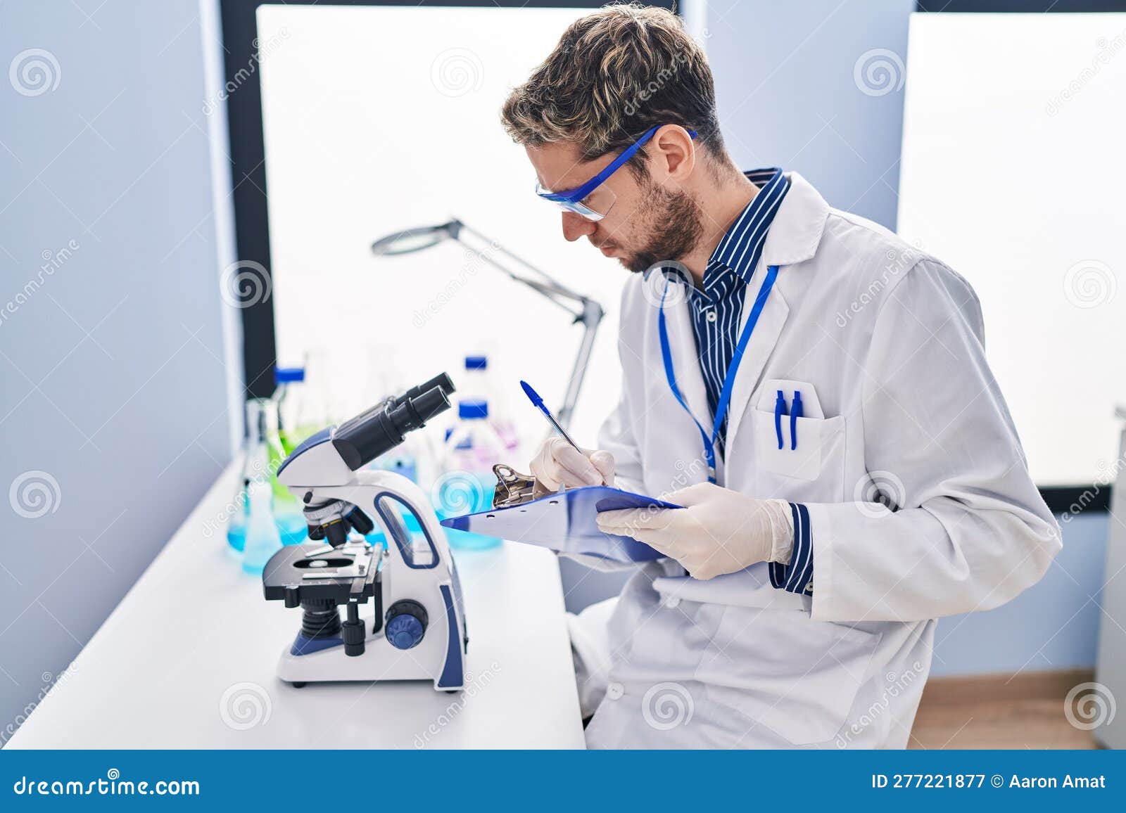 Young Man Scientist Writing Report Working at Laboratory Stock Image ...