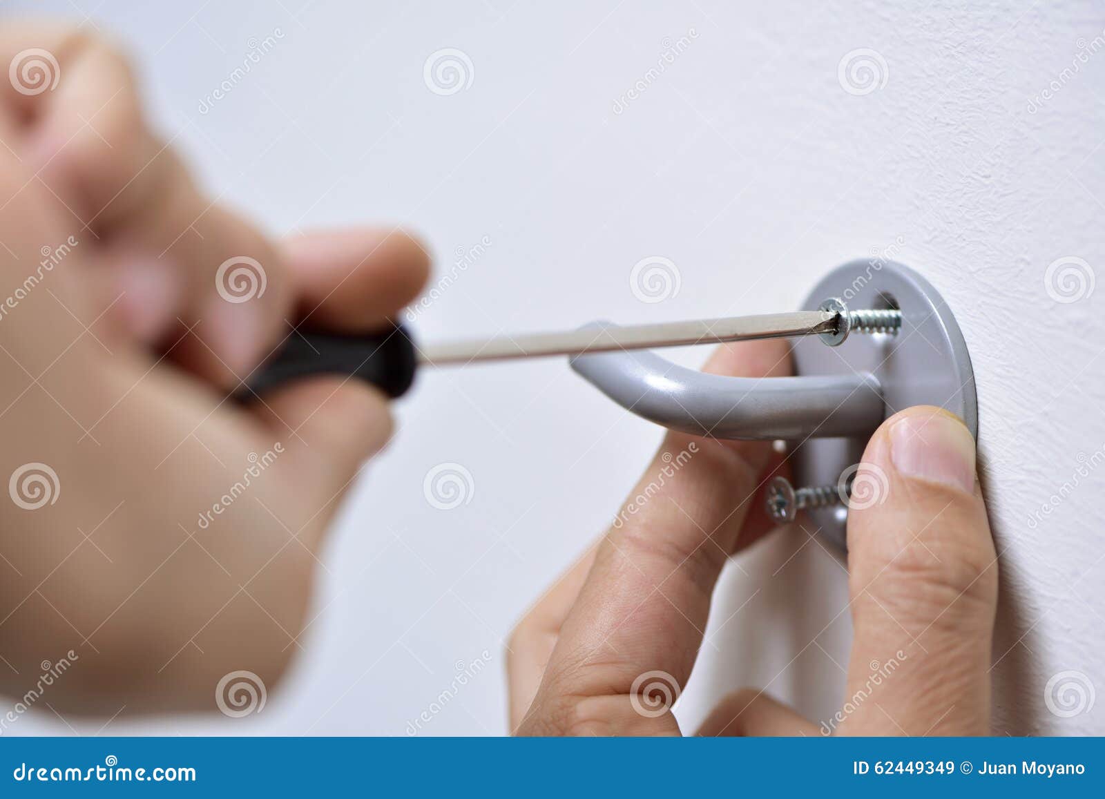 Constructor Screwing A Nut Onto A Metal Screw And Tightly Secure A Part ...