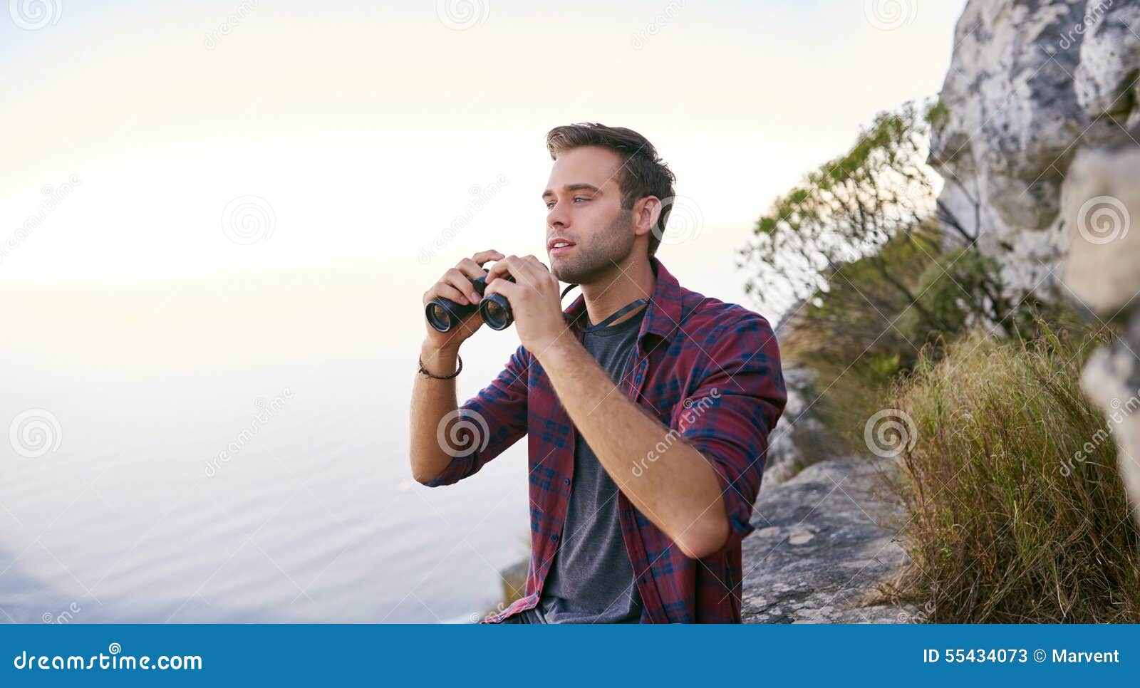 Young Man Searching for Sights with His Binoculars Outdoors Stock Image ...