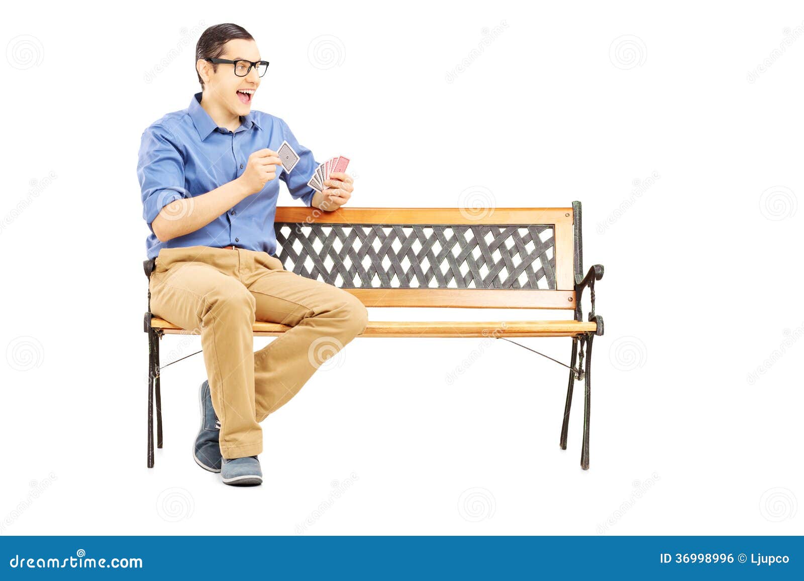 Young Man Seated on Bench Playing Cards Alone Stock Photo - Image of ...