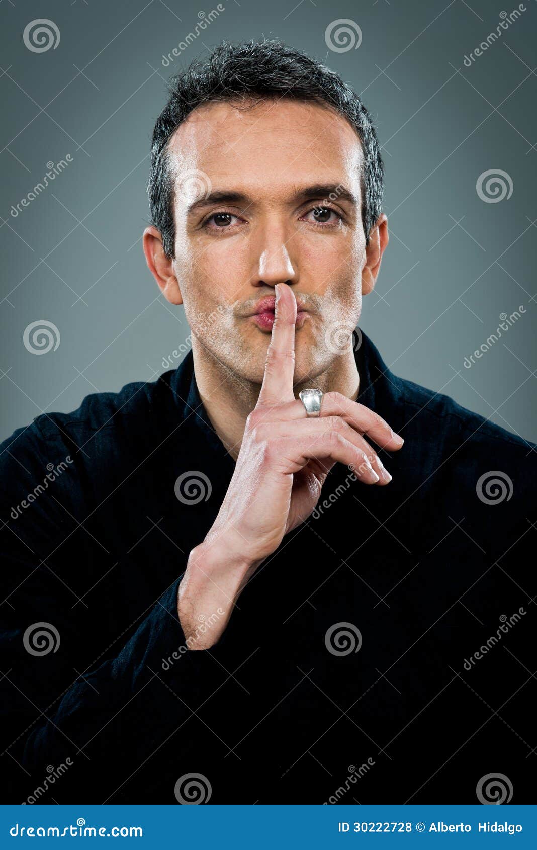 Young Man with Serious Expression Doing a Silent Sign Stock Photo ...