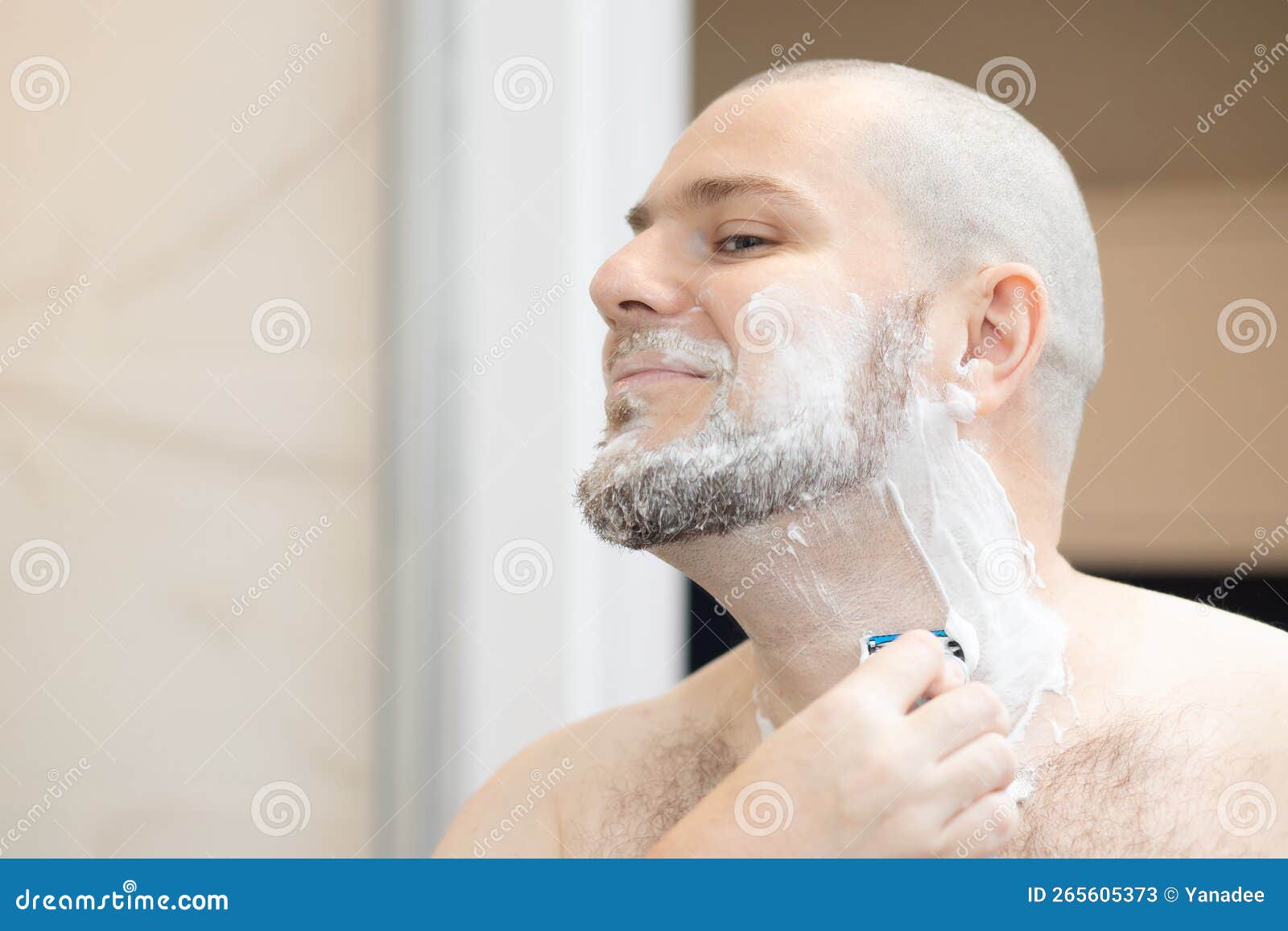 Young Man Shaves His Beard in the Bathroom, Men`s Cosmetics, Shaving ... Young Man Shaves His Beard in the Bathroom, Men`s Cosmetics, Shaving ...