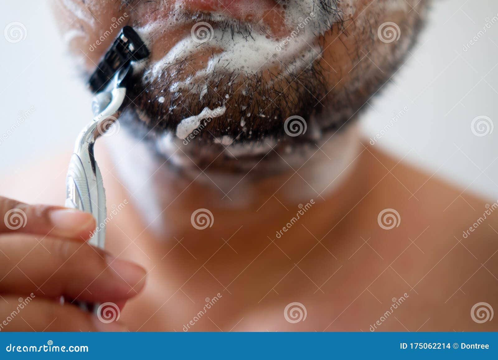 Young man shaving his face stock photo. Image of clean - 175062214