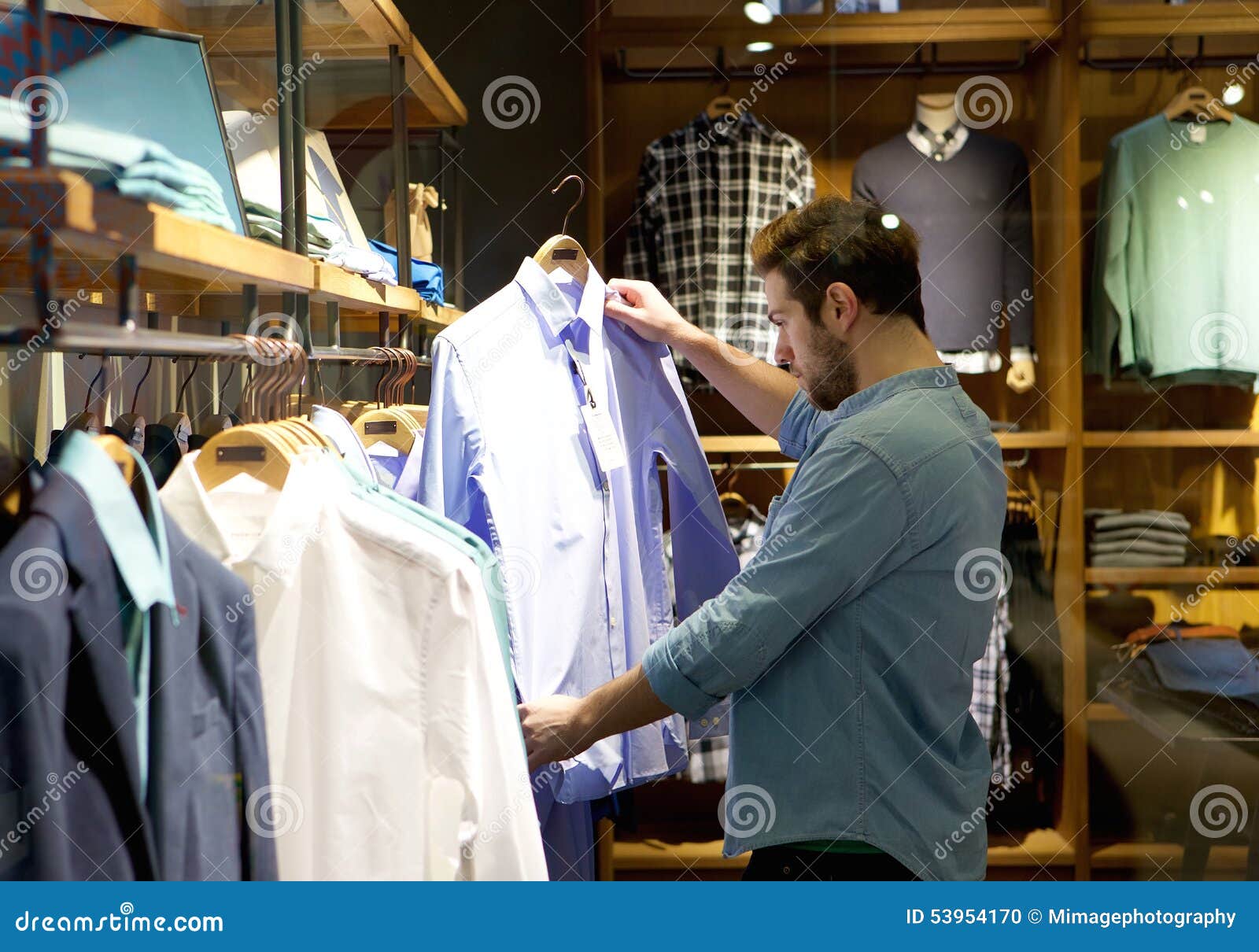 Young Man Shopping for Clothes at Store Stock Photo - Image of buyer ...