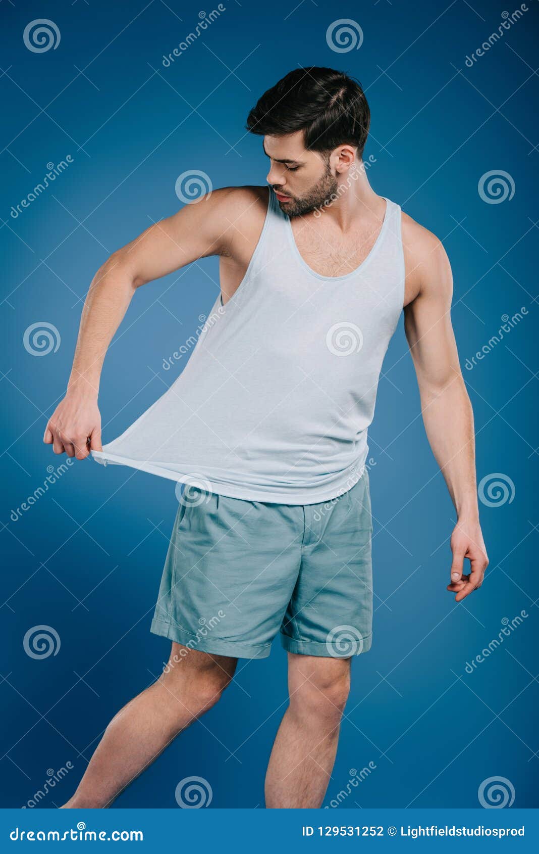 Young Man in Shorts Looking at White Singlet Stock Photo - Image of ...