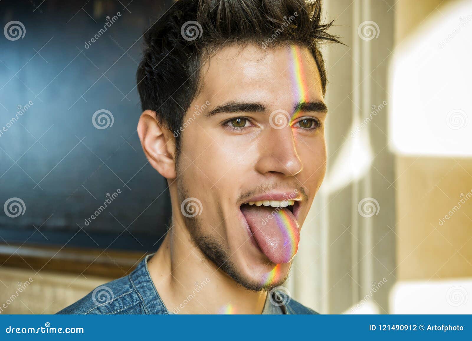 Young man showing tongue stock photo. Image of caucasian - 121490912