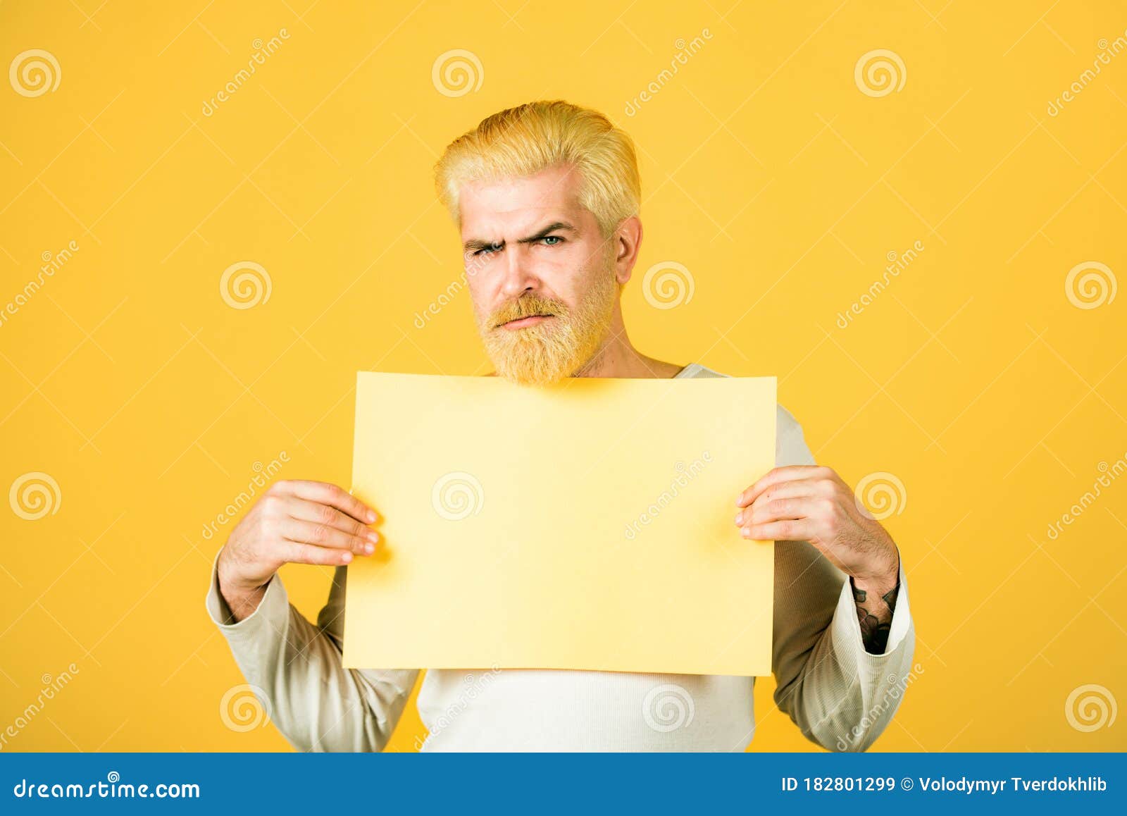 Young Man Shows a Sheet of Paper in the Camera on a Color Background ...