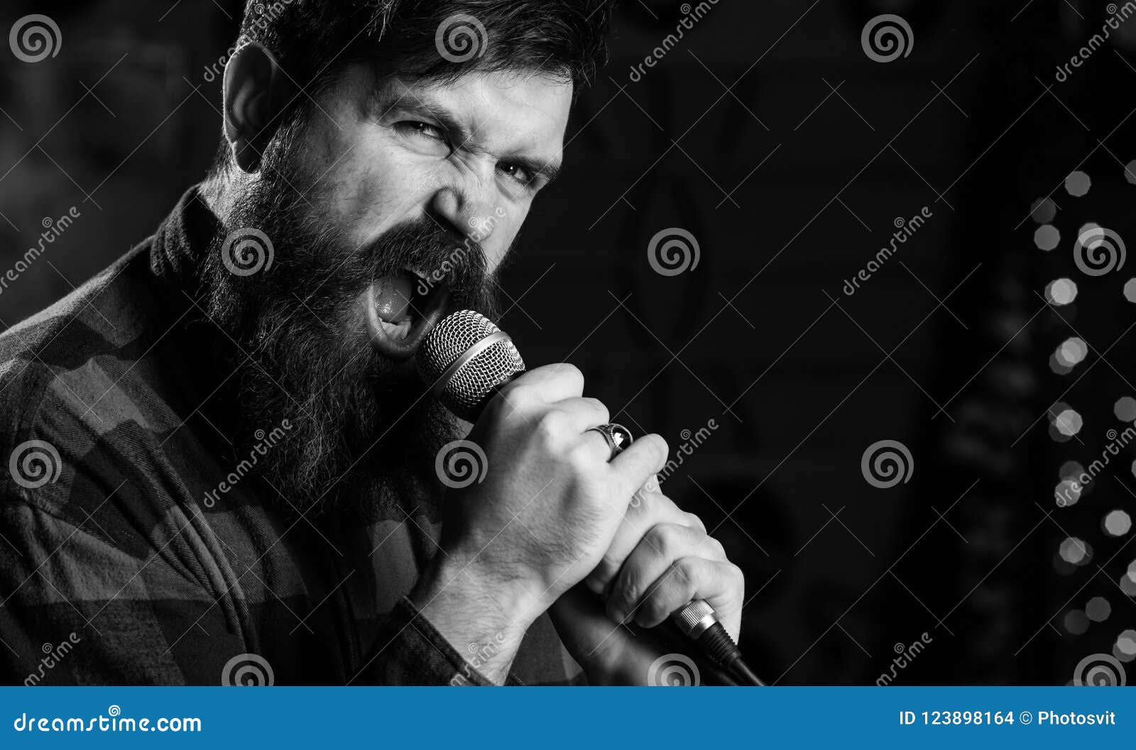 Young Man Singing with Microphone. Hipster with Beard Stock Photo ...