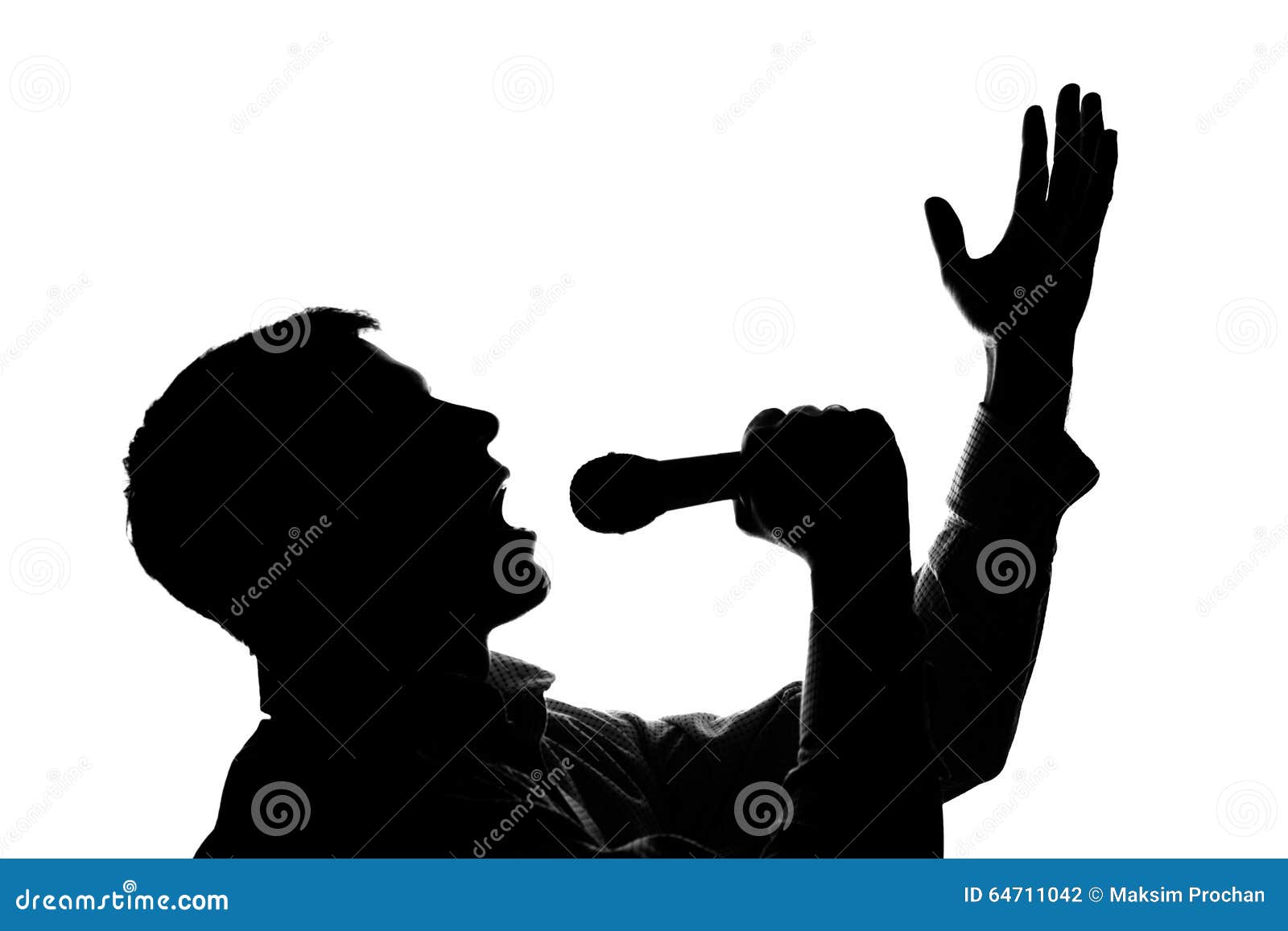 A Young Man Singing into a Microphone Raising His Hands Stock Photo ...