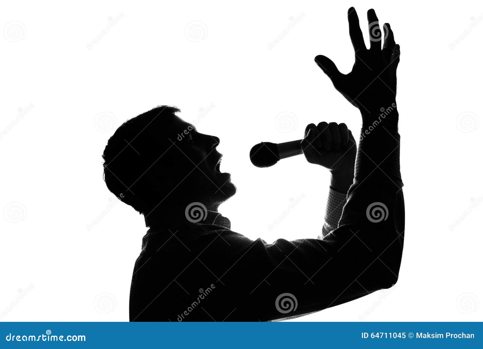 A Young Man Singing into a Microphone Raising His Hands Stock Image ...