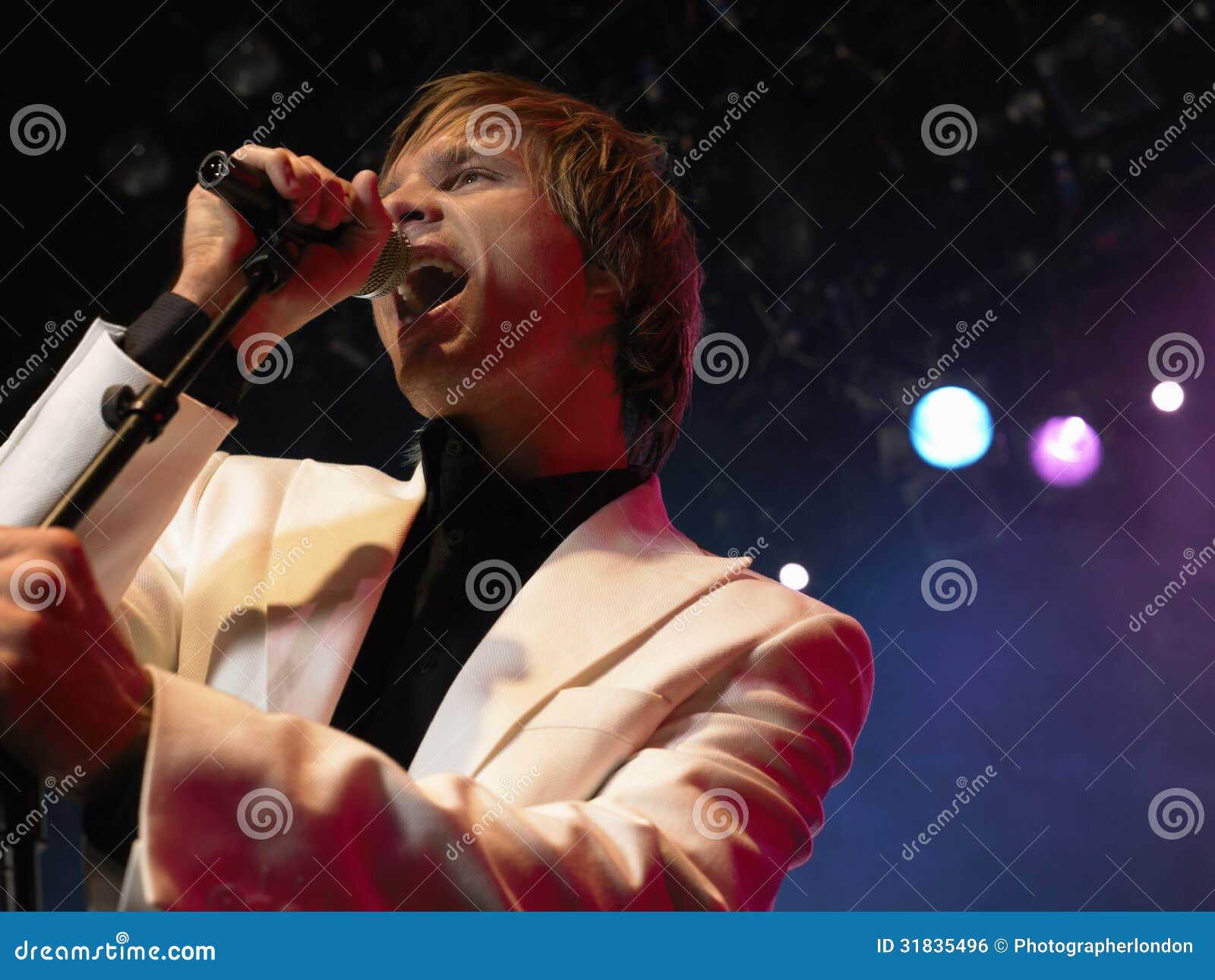 Young Man Singing into Microphone Stock Photo - Image of person, adult ...