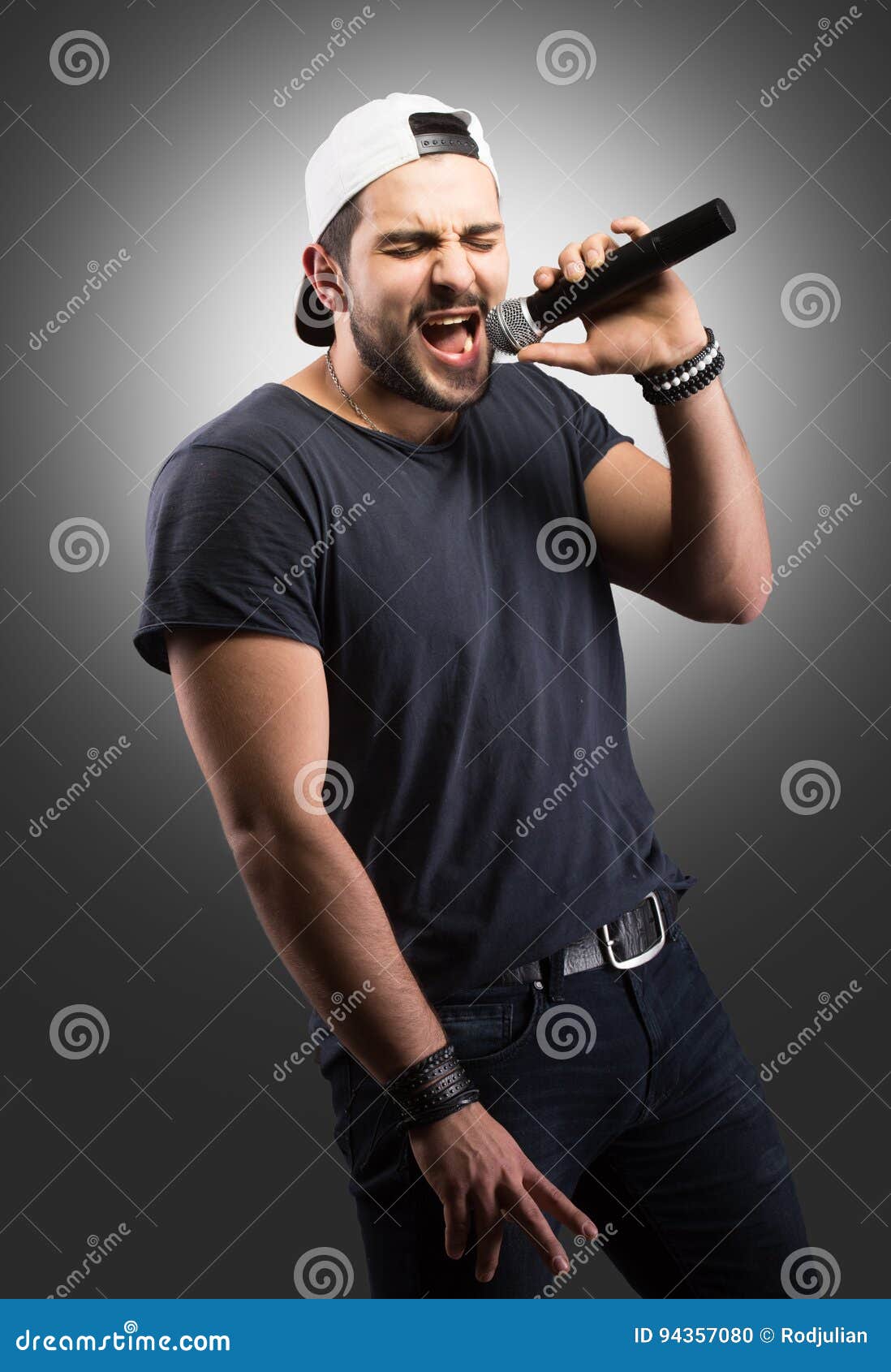 Young Man Singing into a Microphone Stock Photo - Image of shirt ...