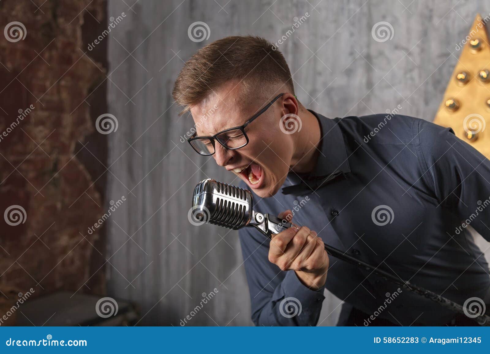 Young Man Singing with Microphone Stock Image - Image of glamour ...