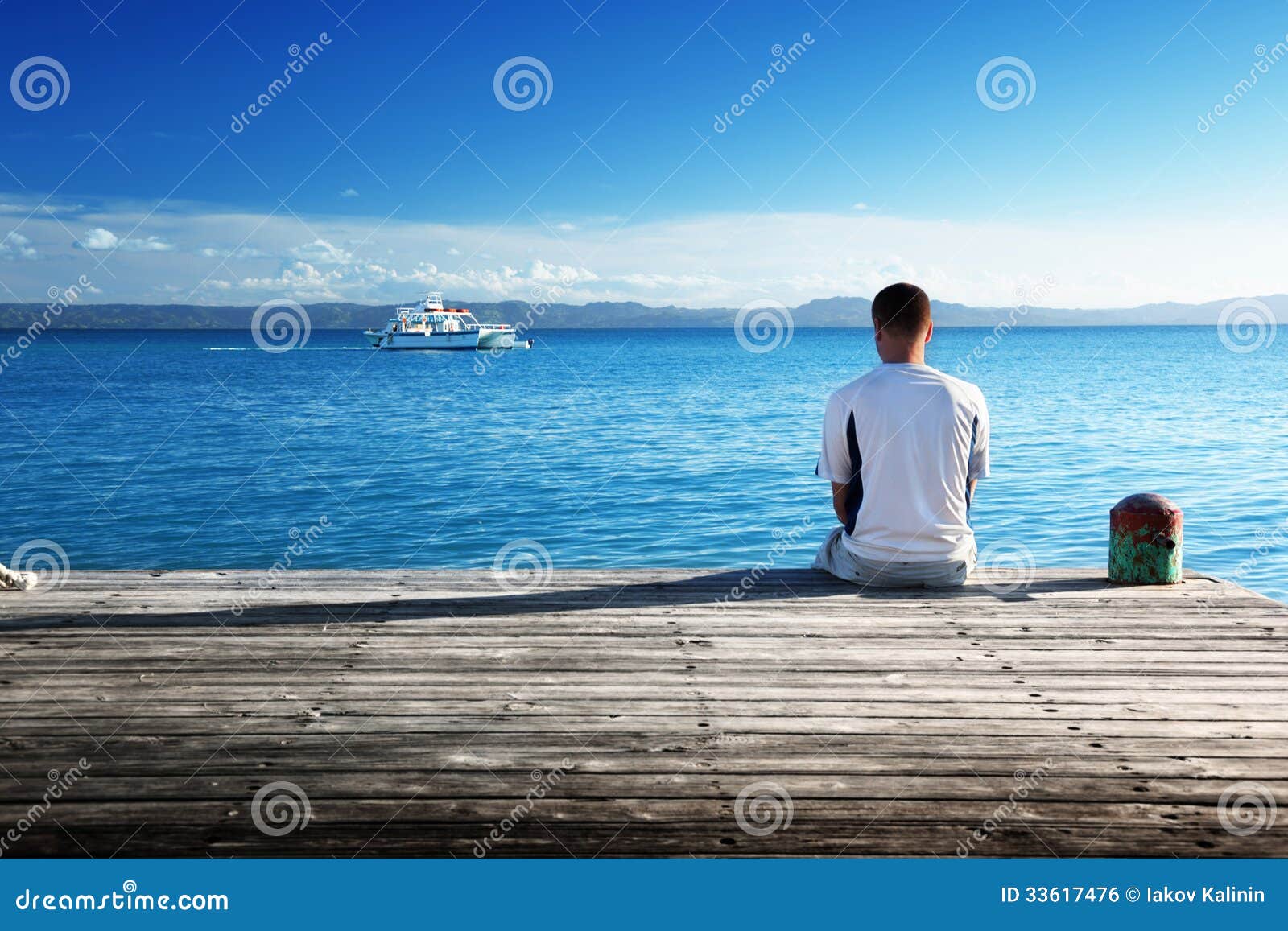 Young man siting on pier stock photo. Image of depressed - 33617476