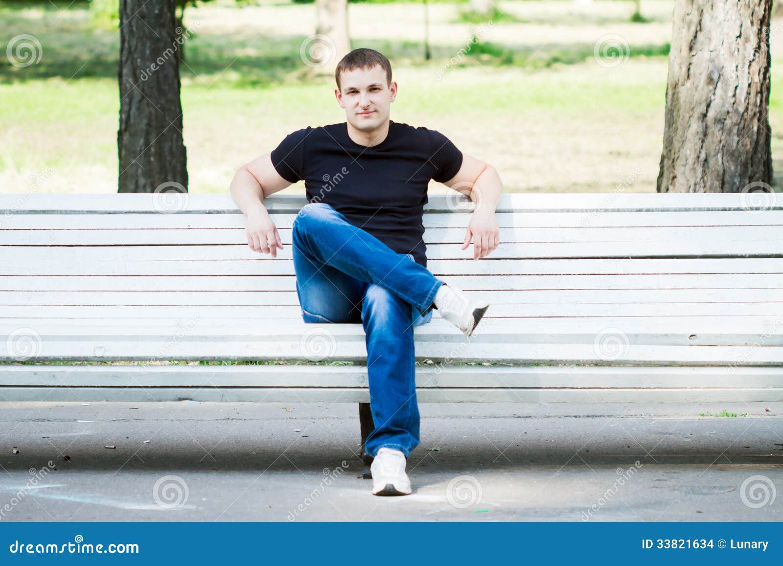 The Young Man Sits on a Bench Stock Photo - Image of adult, color: 33821634