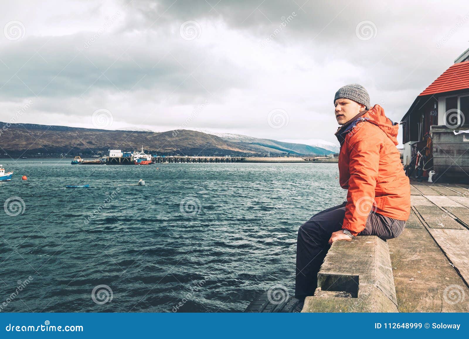 Young man sits on the pier stock image. Image of enjoy - 112648999
