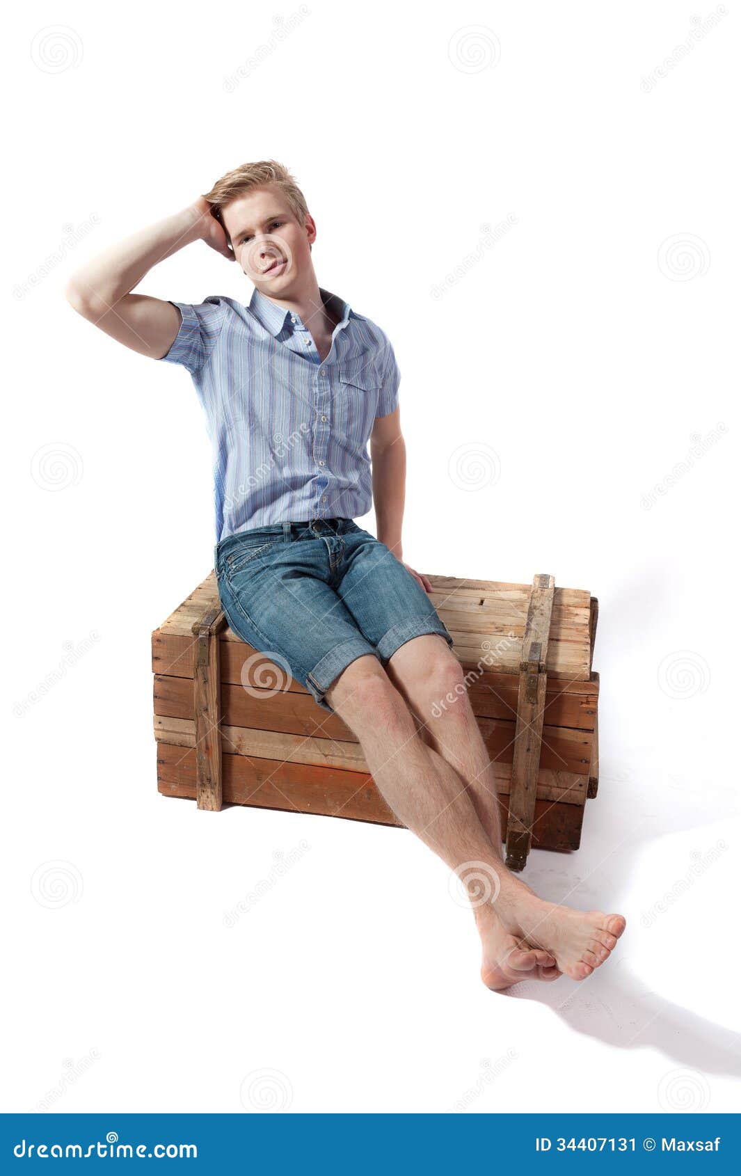 Young Man Sits on Wooden Box Stock Image - Image of young, stretch ...