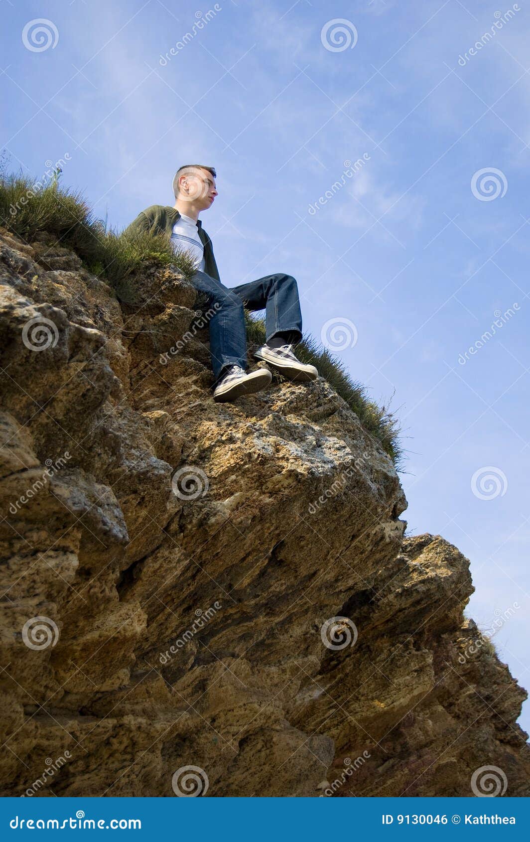 A Young Man Sitting Alone on the Cliff Stock Photo - Image of heather ...