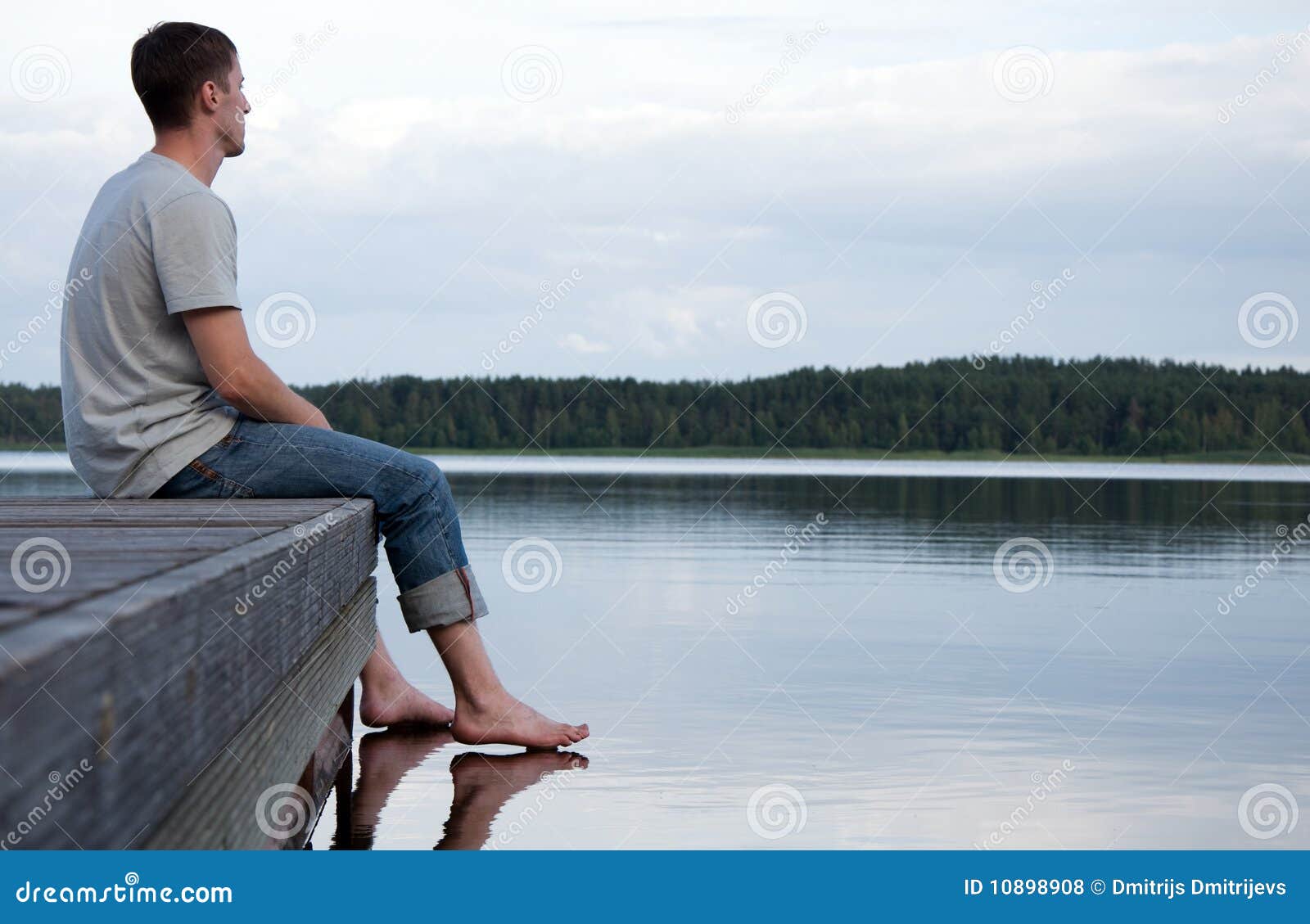 A Young Man Sitting Alone by the Water Stock Photo - Image of dream ...