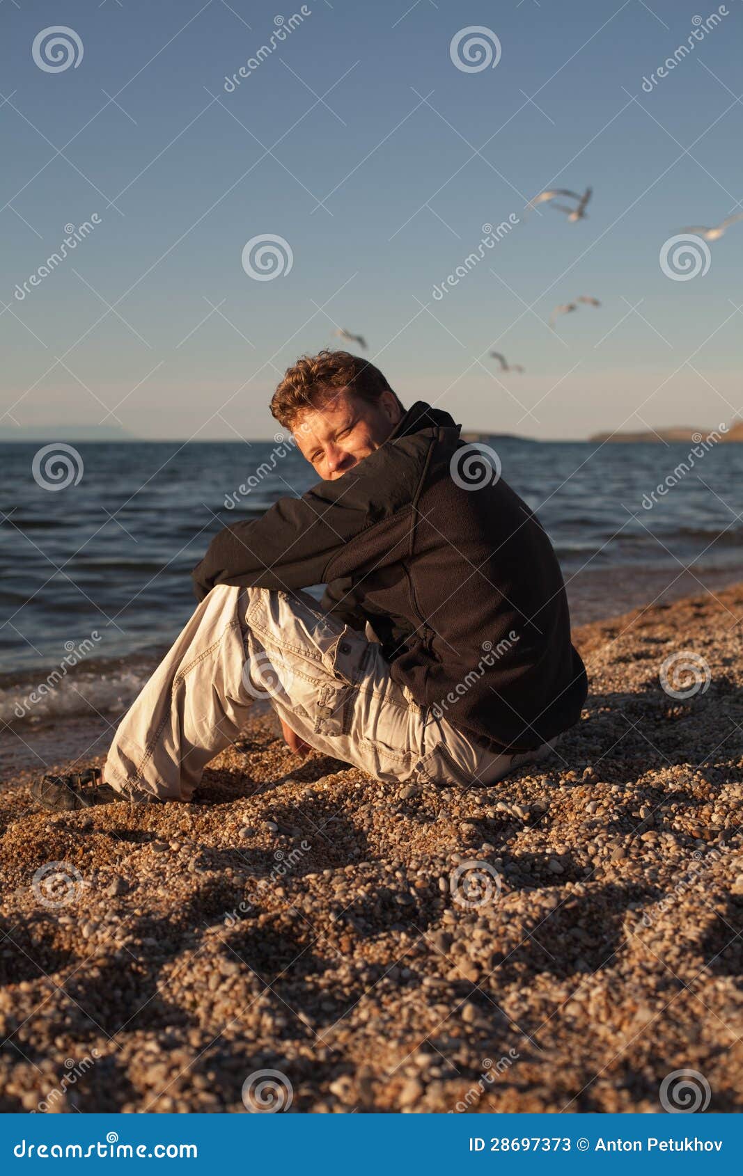 Young Man Sitting on the Beach Stock Image - Image of island, baikal ...