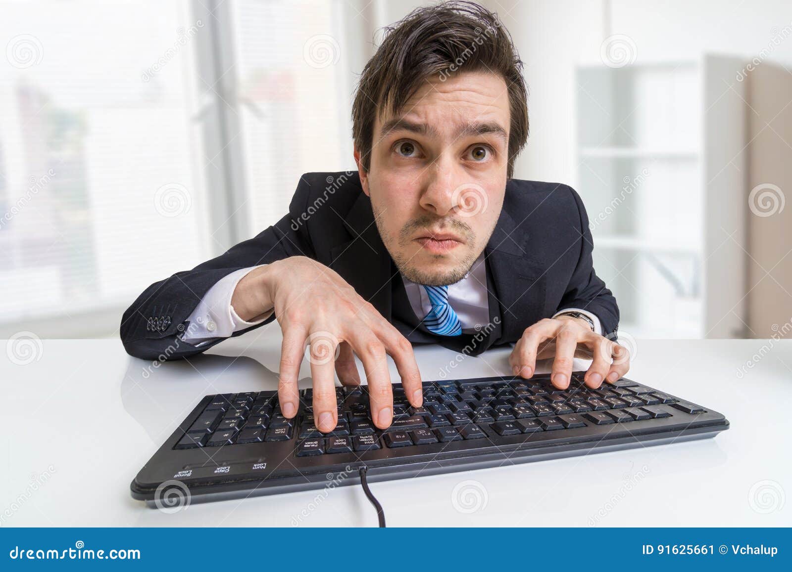 Young Man is Sitting Behind Table and Working with Computer Stock Image ...