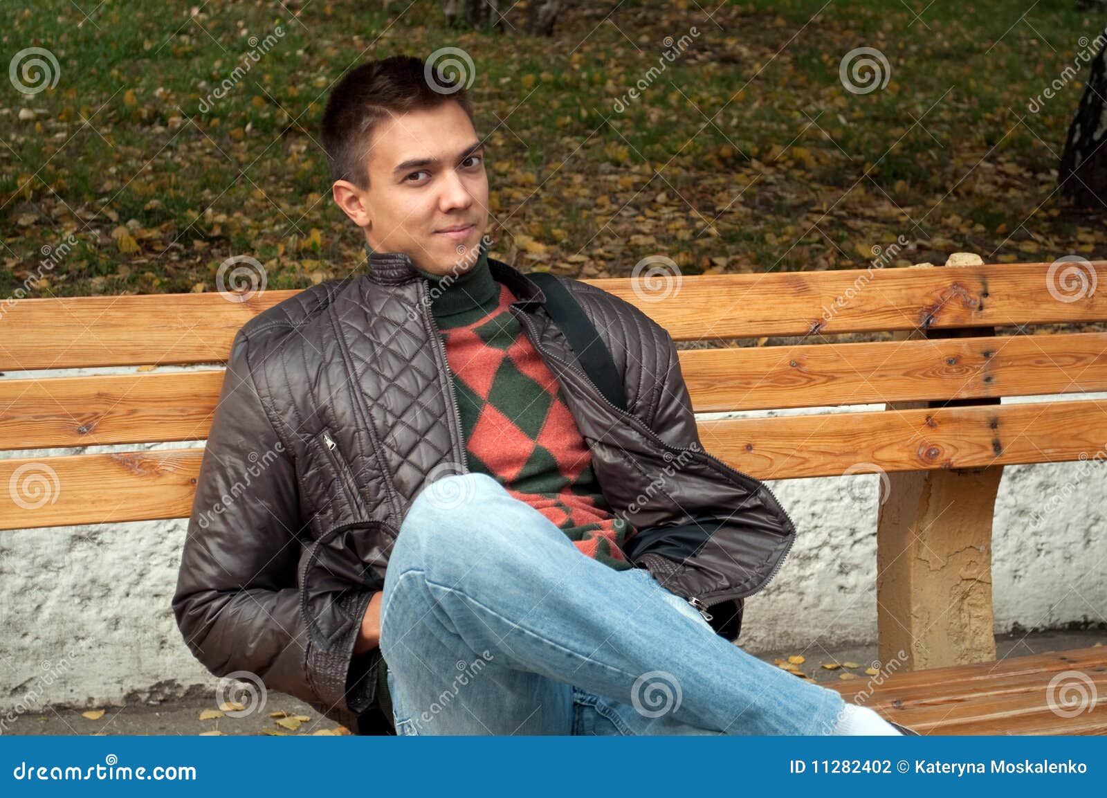 Young Man Sitting on a Bench in Autumn Park Stock Photo - Image of ...