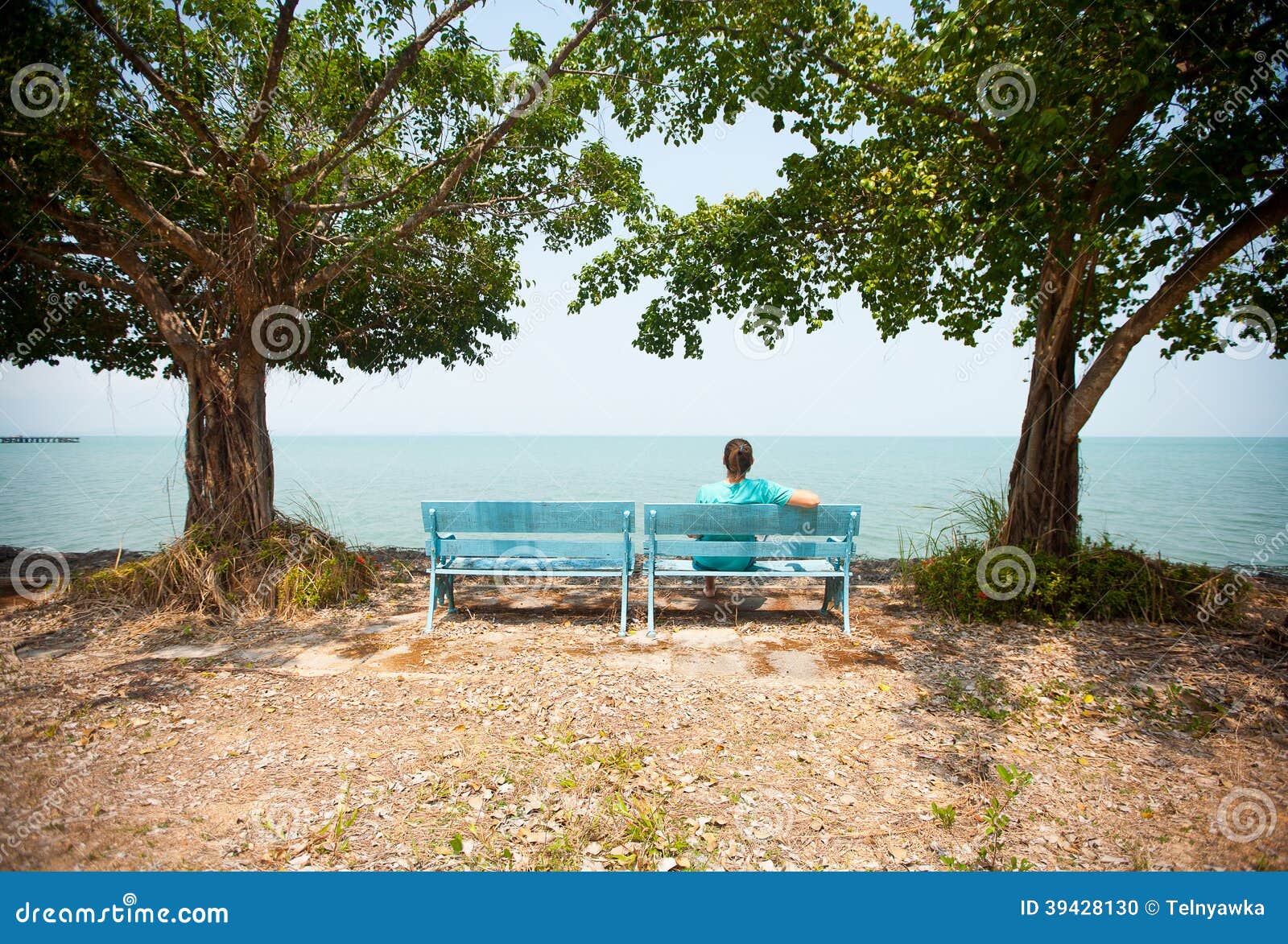 Young Man Sitting on Bench Facing the Sea Stock Photo - Image of ...