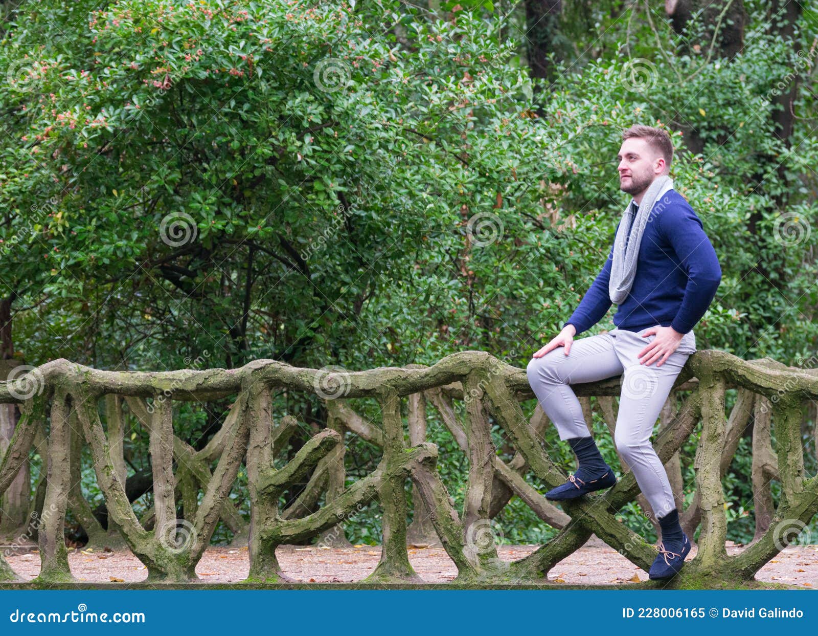Young Man Sitting on Bridge with Stone Railing Stock Image - Image of ...
