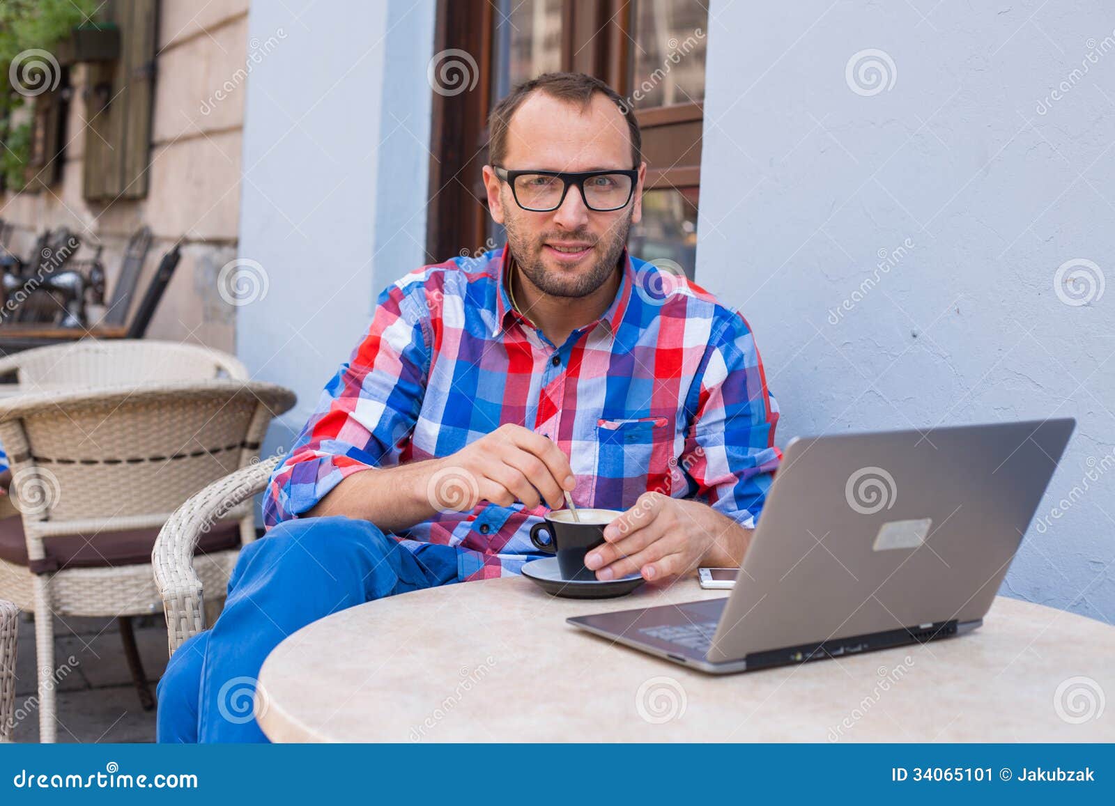 Young Man Sitting in Cafe with Laptop and Coffee. Stock Image - Image ...