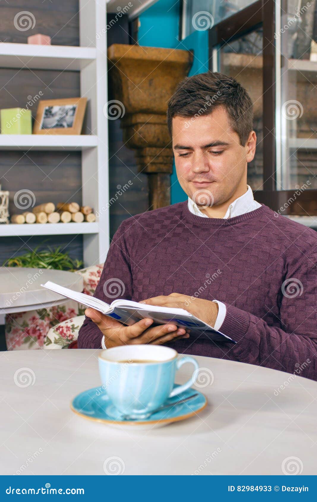 Young Man Sitting in Cafe and Reading a Book Stock Image - Image of ...
