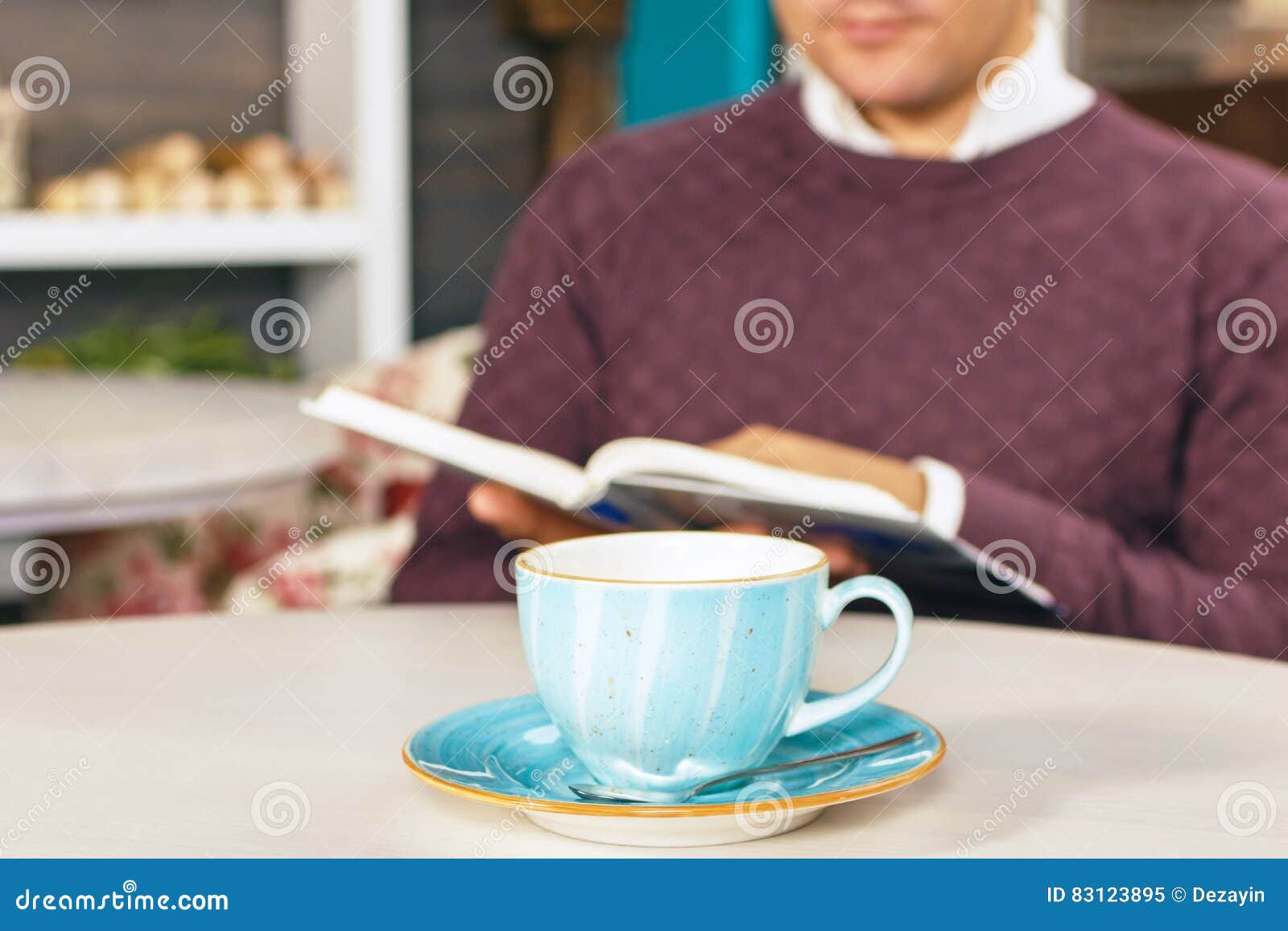 Young Man Sitting in Cafe and Reading a Book Stock Image - Image of ...